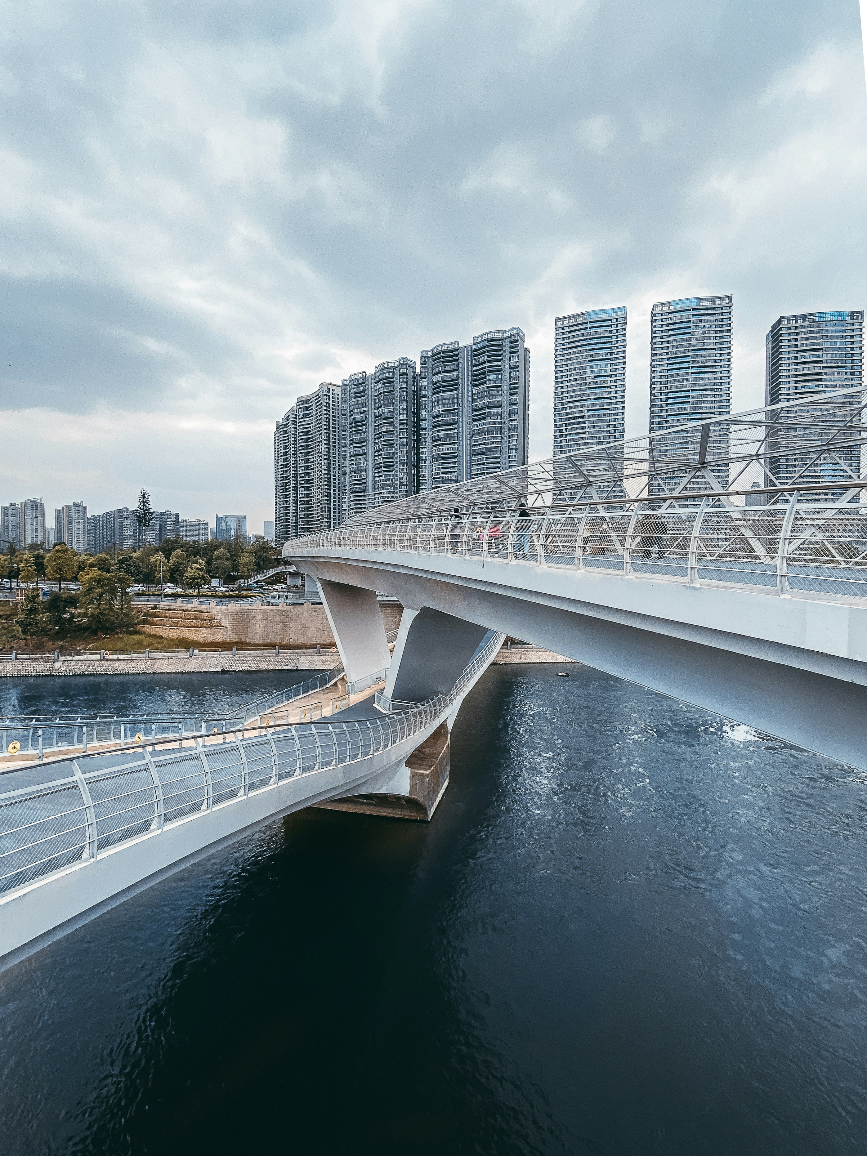 White bridge over river near city buildings during daytime photo – Free ...
