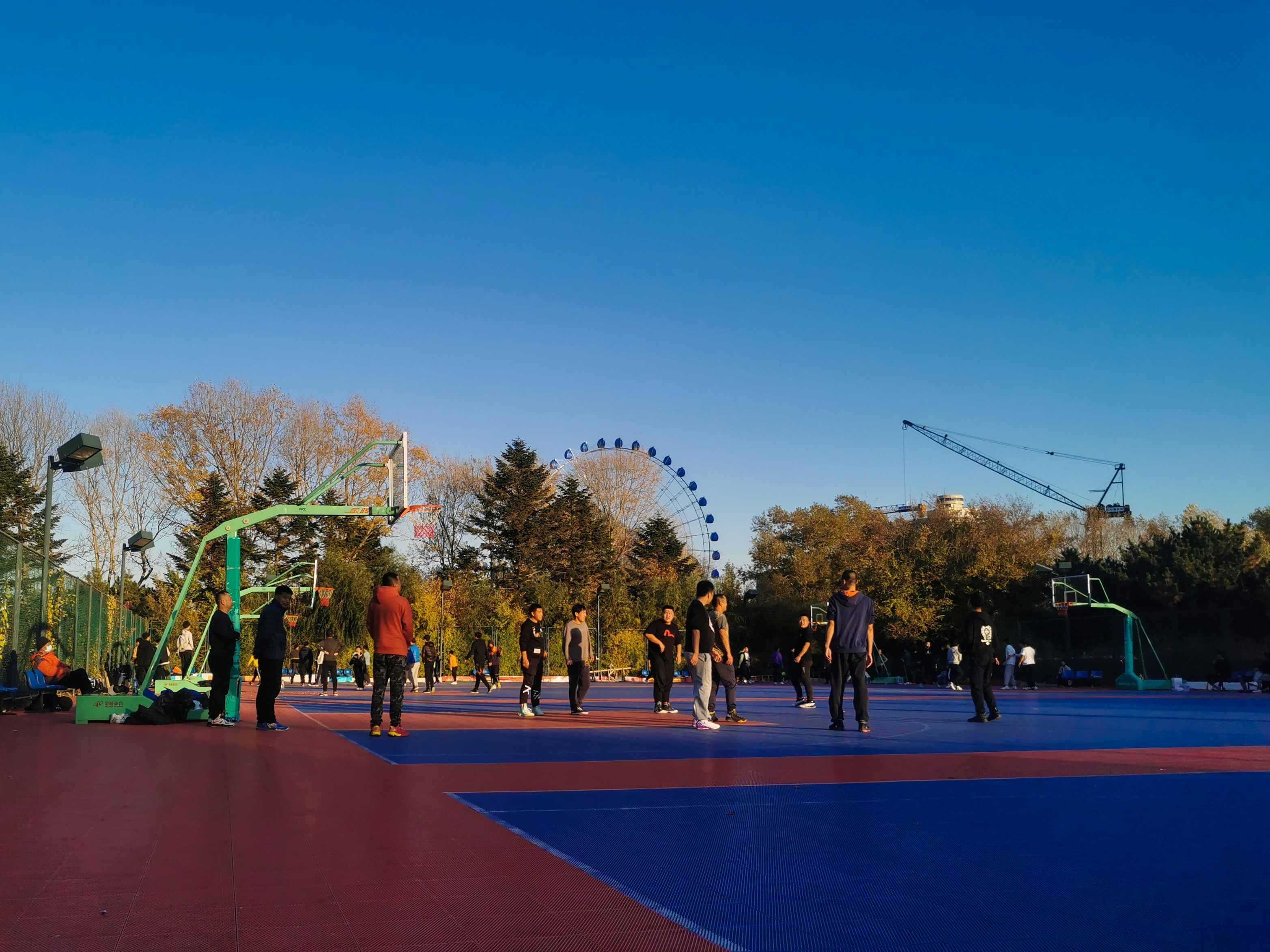 Two-Tone Court Play Under a Ferris Wheel Backdrop