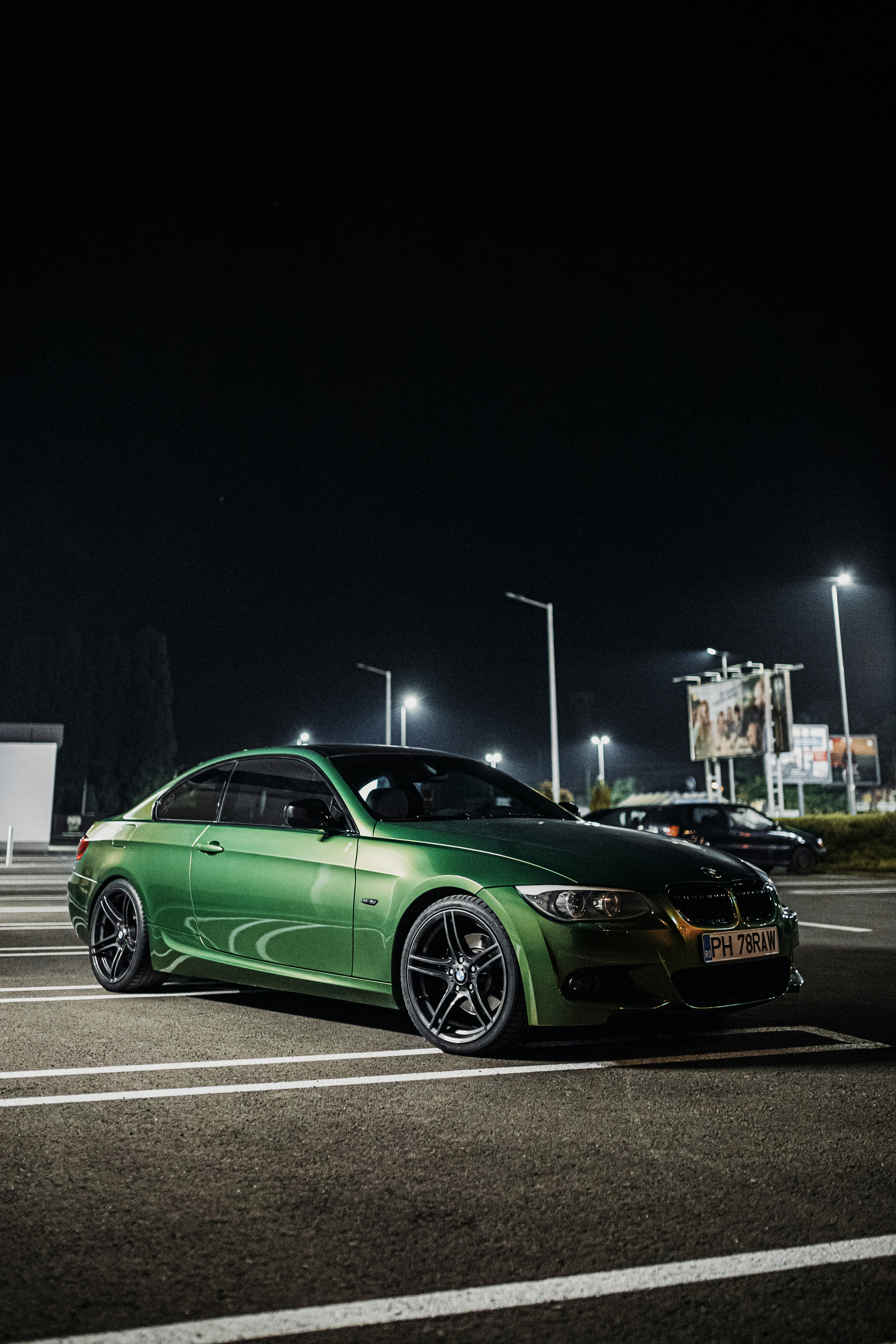 Emerald Momentum: Night-stopped BMW in a Neon Parking-Lot Glow