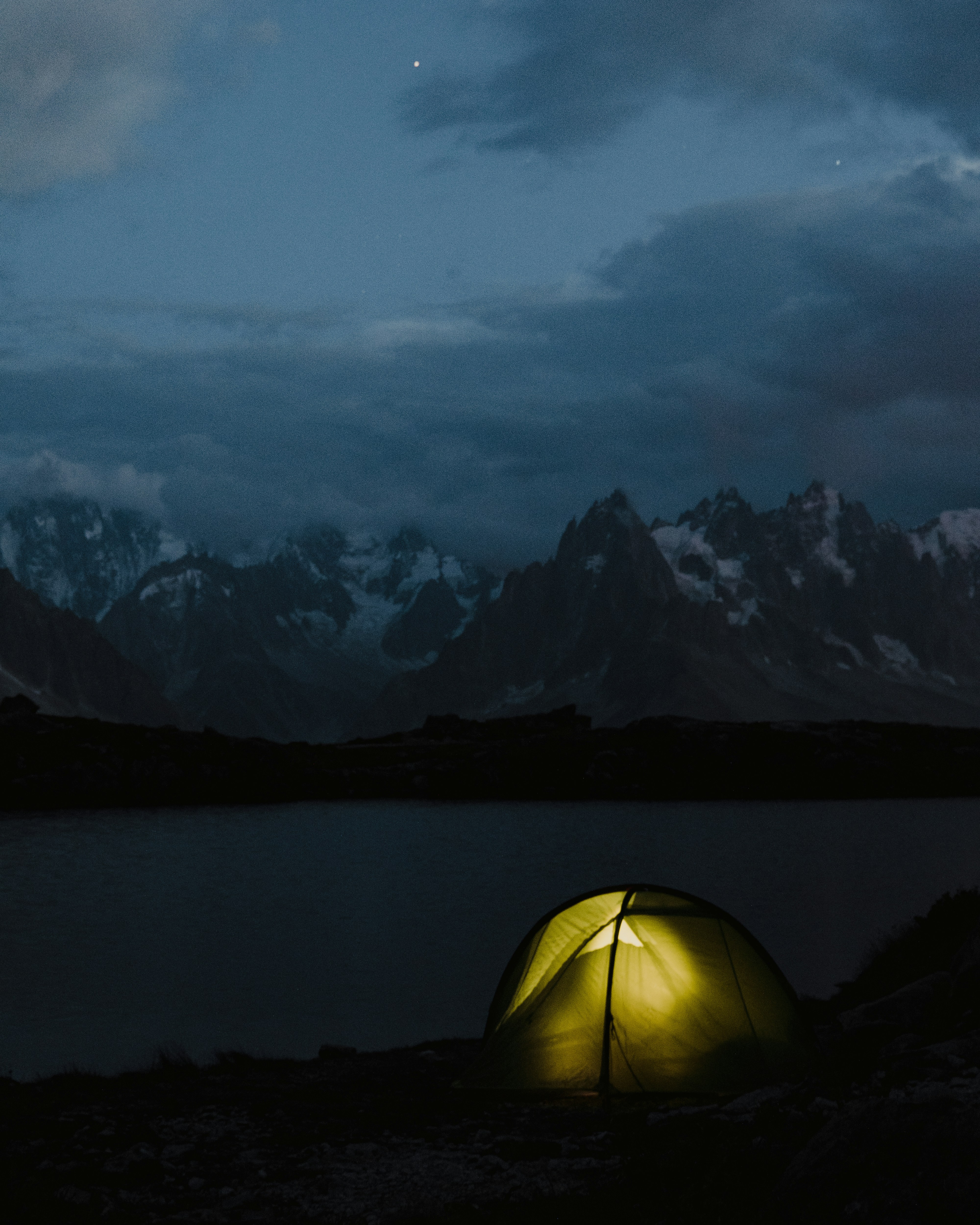 Glowing Camp at the Foot of Silent Peaks