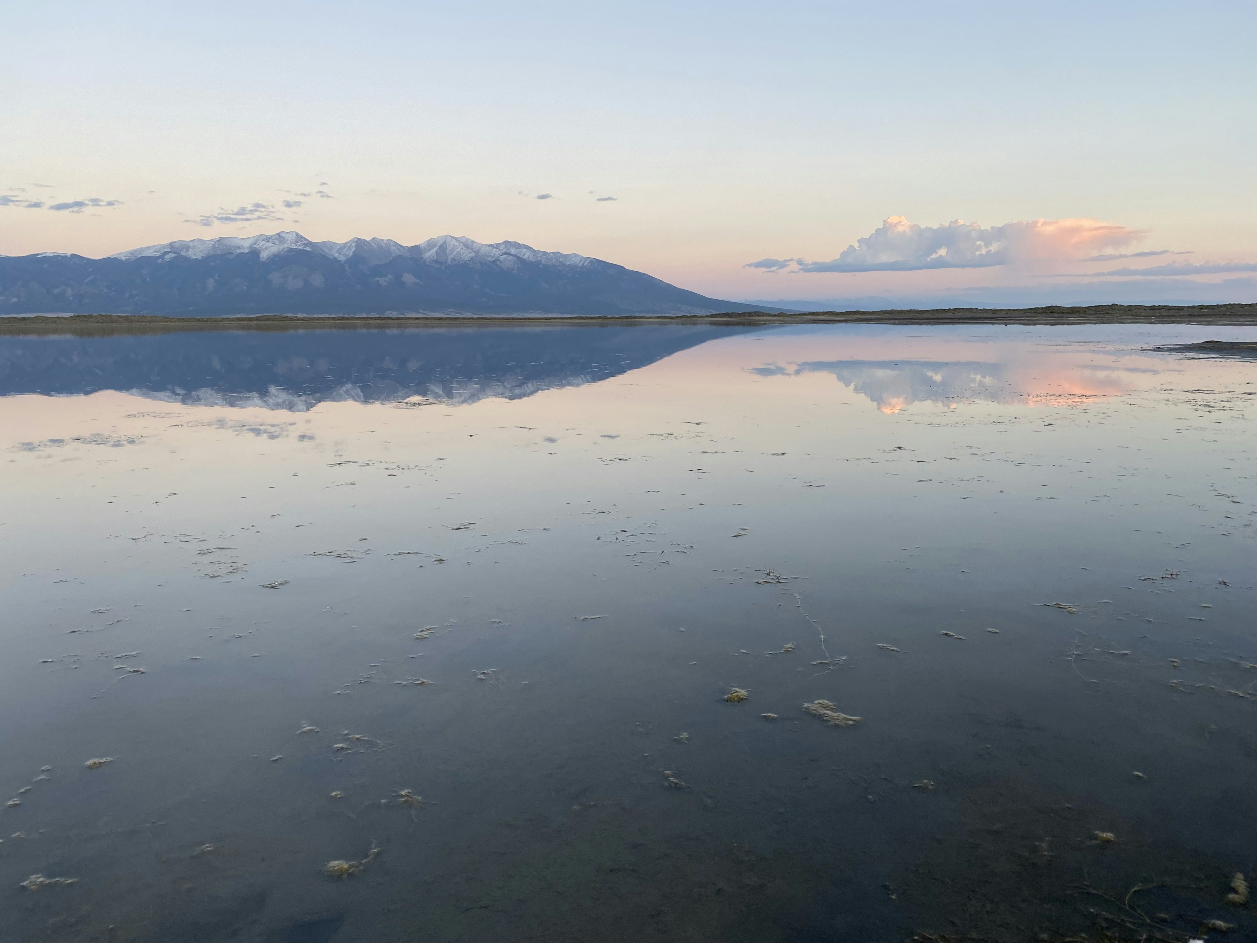 calm water with mountain in distance