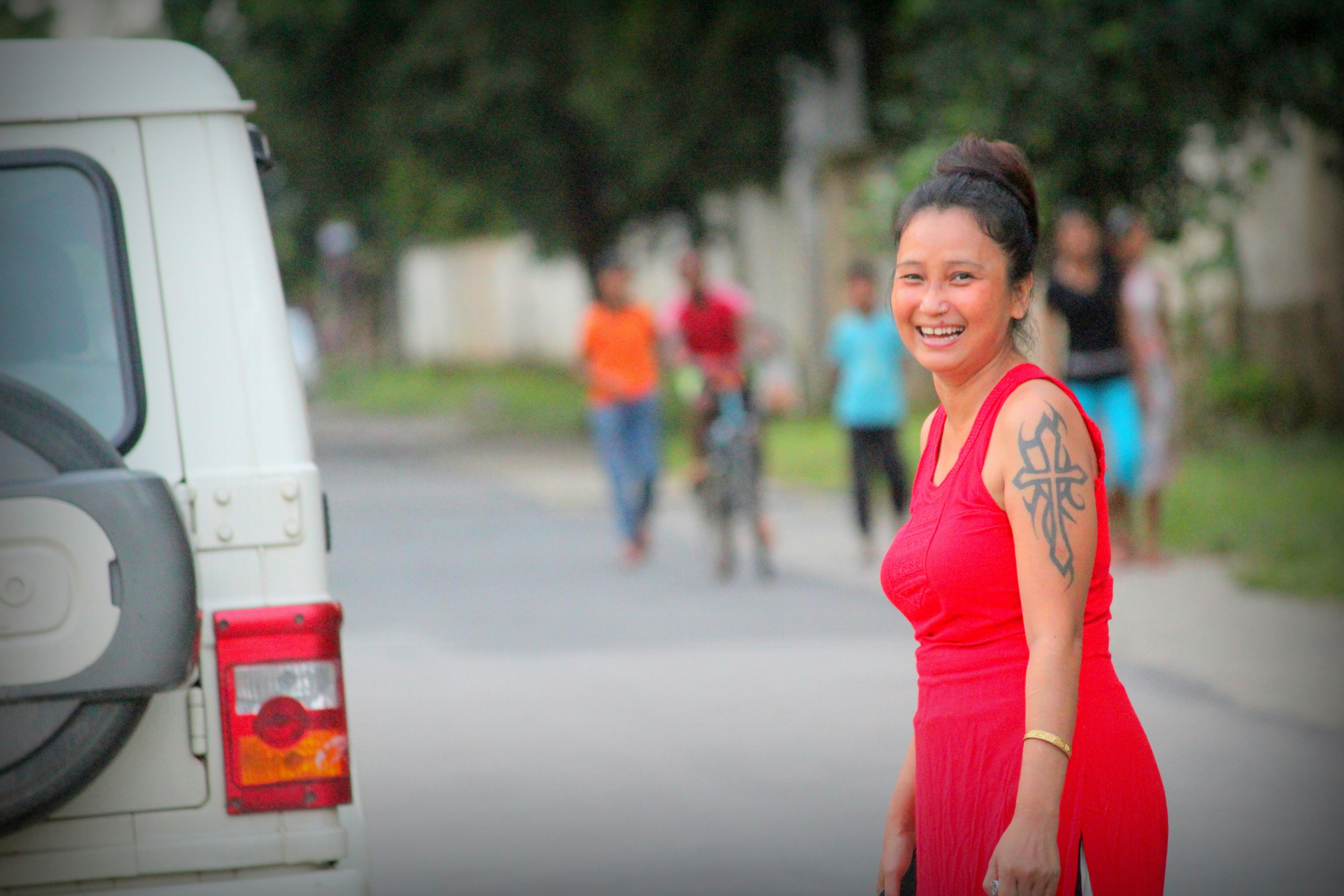 Woman in orange tank top standing on road during daytime photo – Free ...