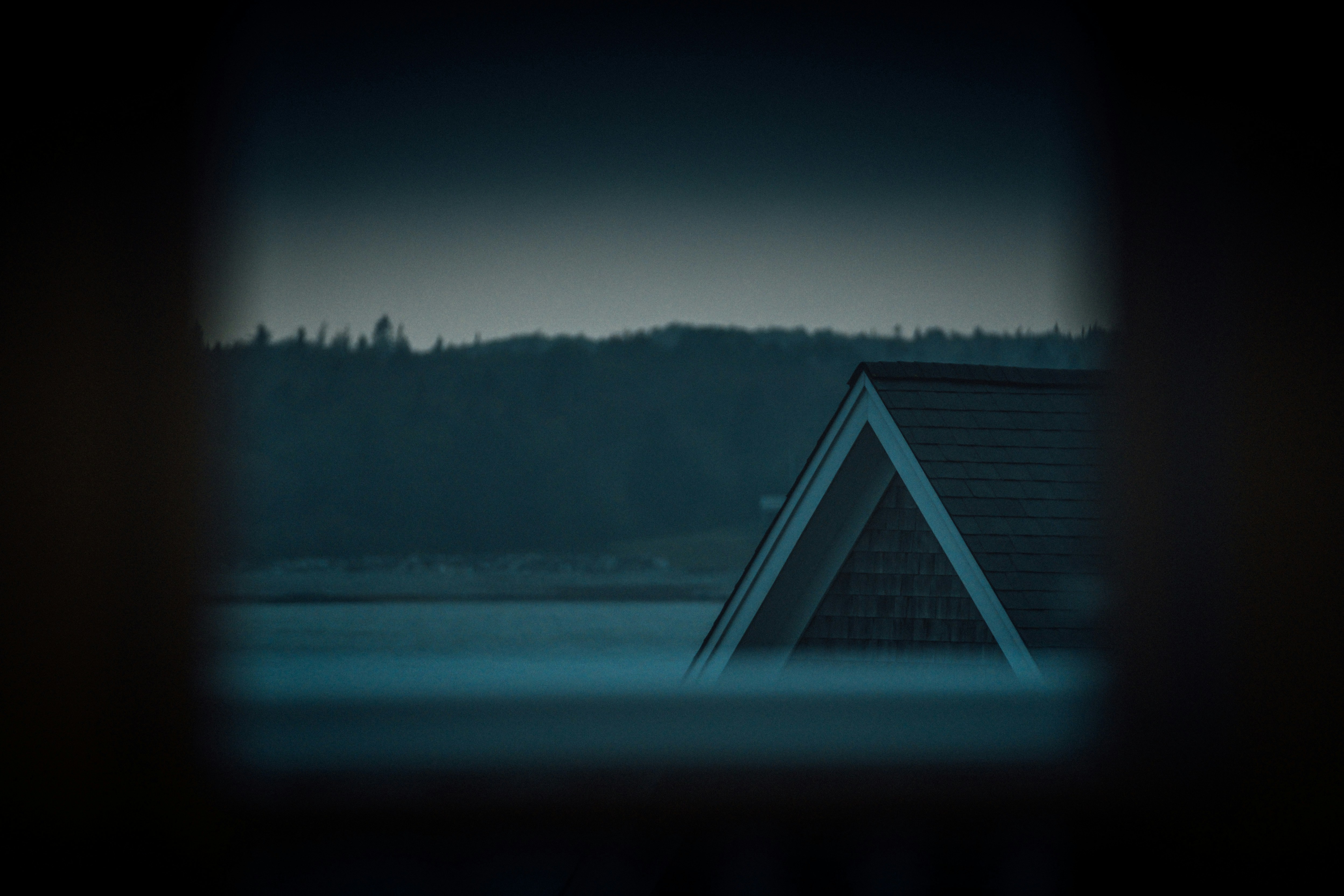 Snowy Roofline Framed by a Narrow View