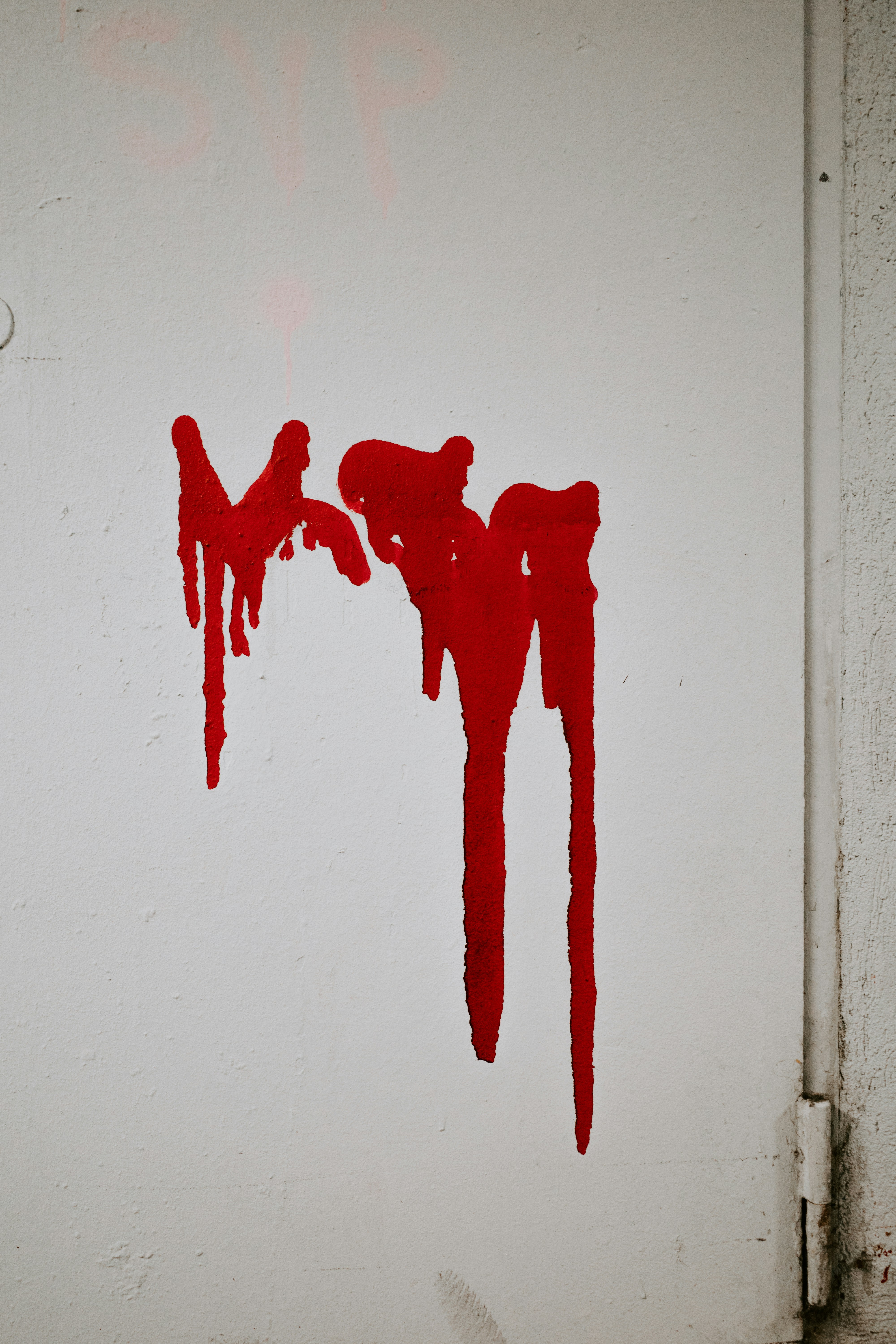 Red hand sign on white wall photo – Free Art Image on Unsplash