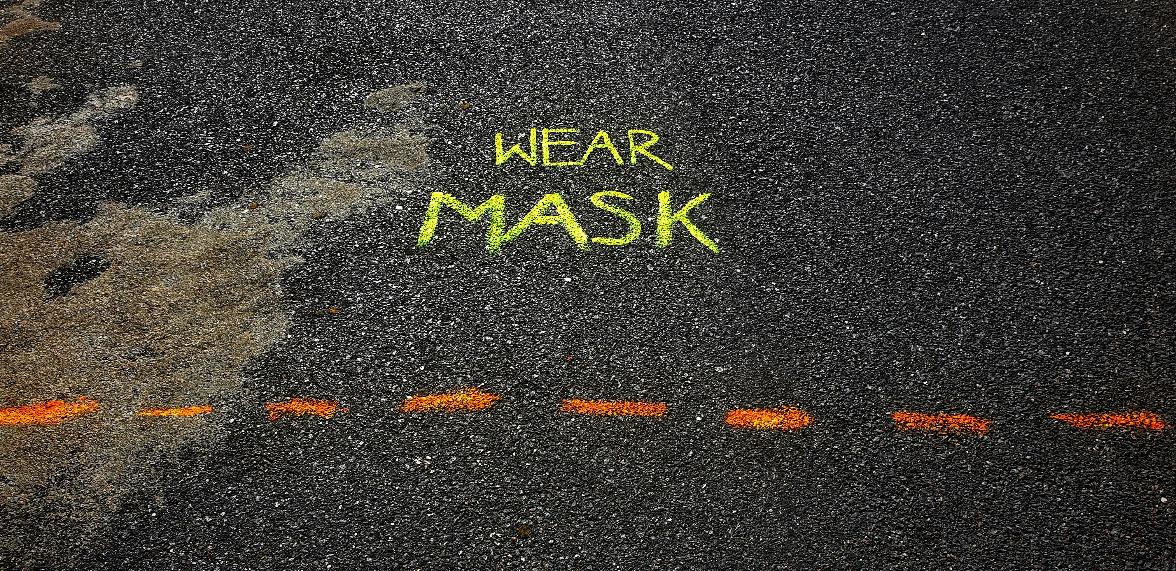 Wear Mask in Bright Yellow Marker on Asphalt