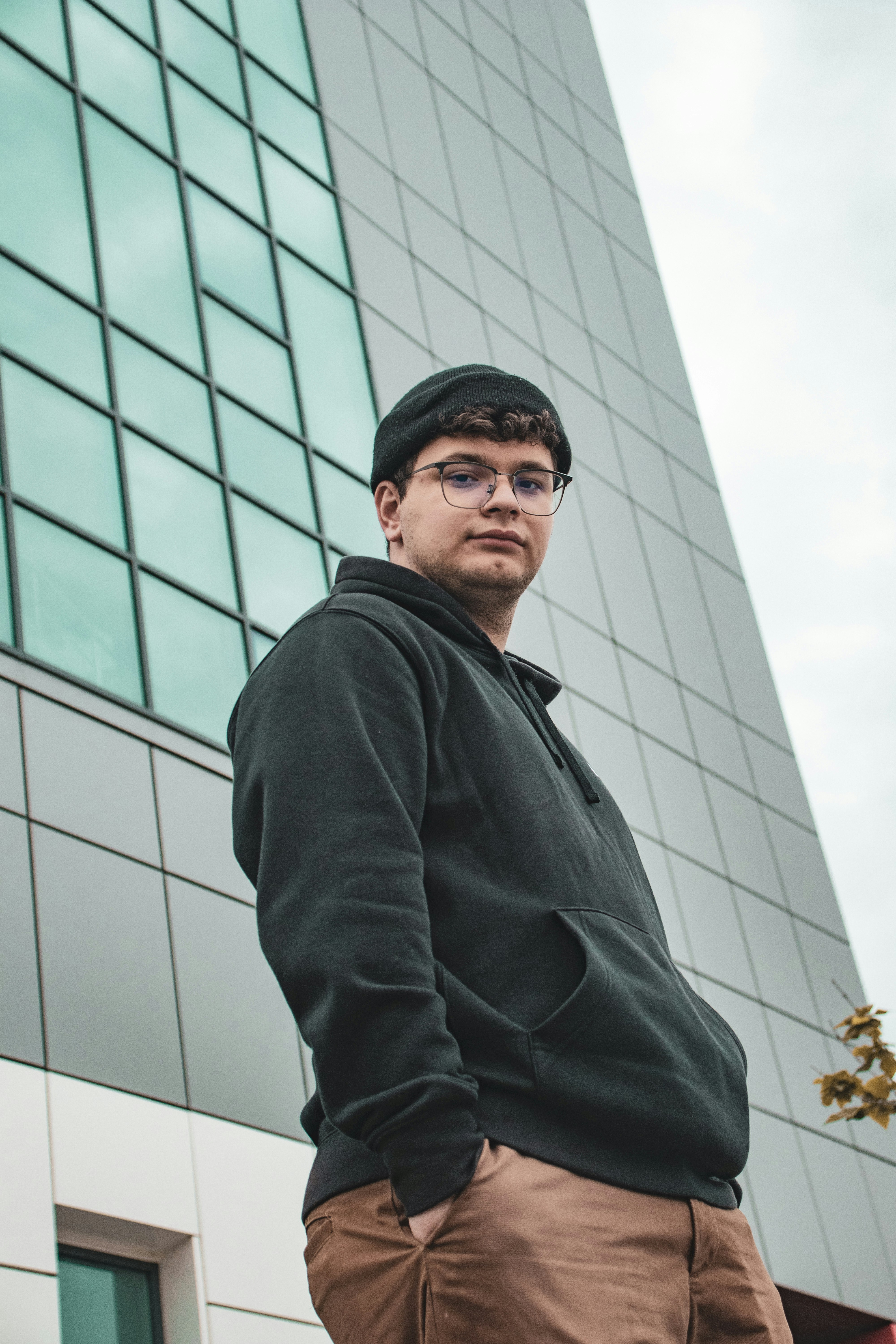 Man in black jacket standing near building during daytime photo – Free ...