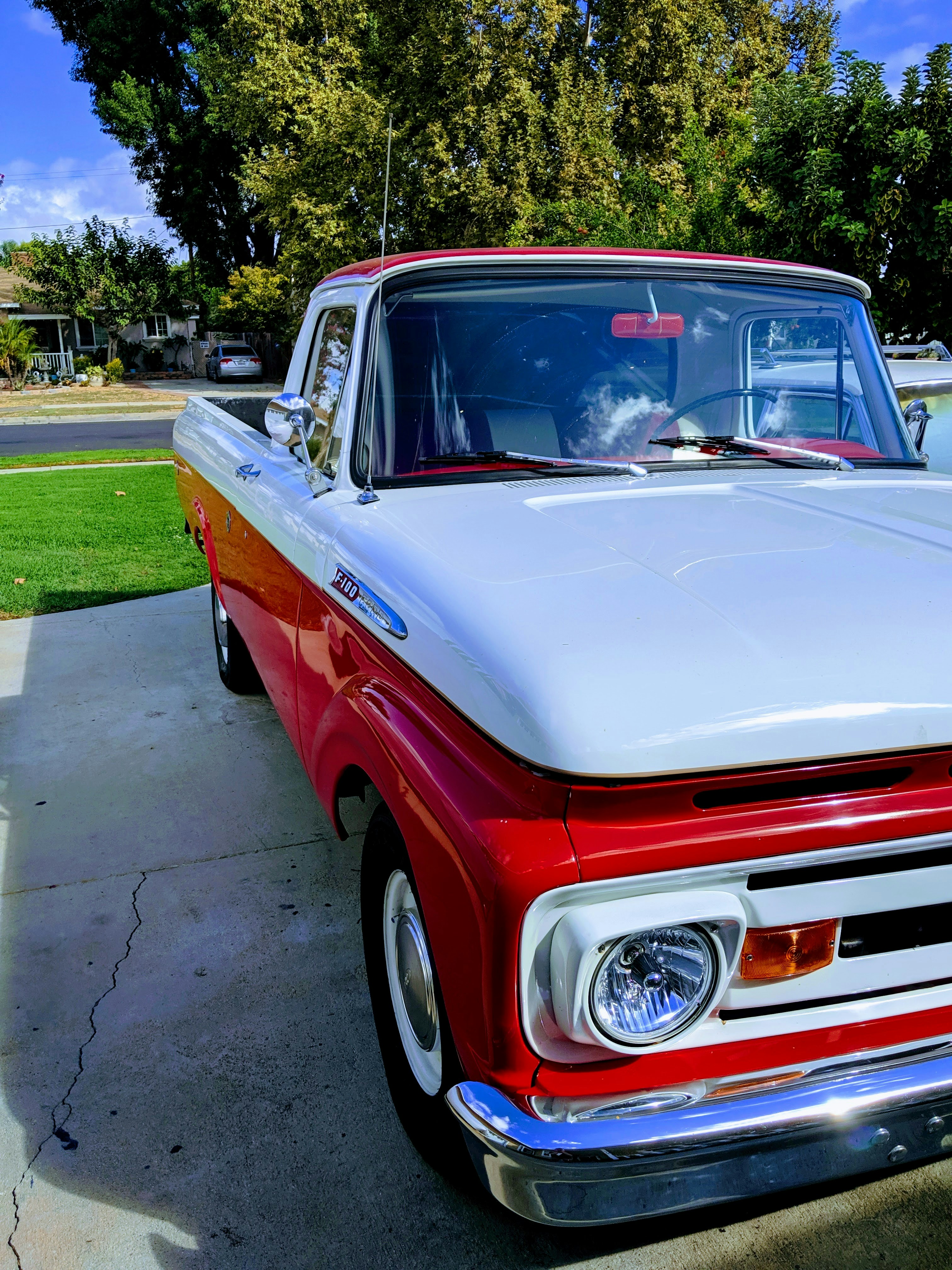 Red and white chevrolet single cab pickup truck parked on gray concrete ...