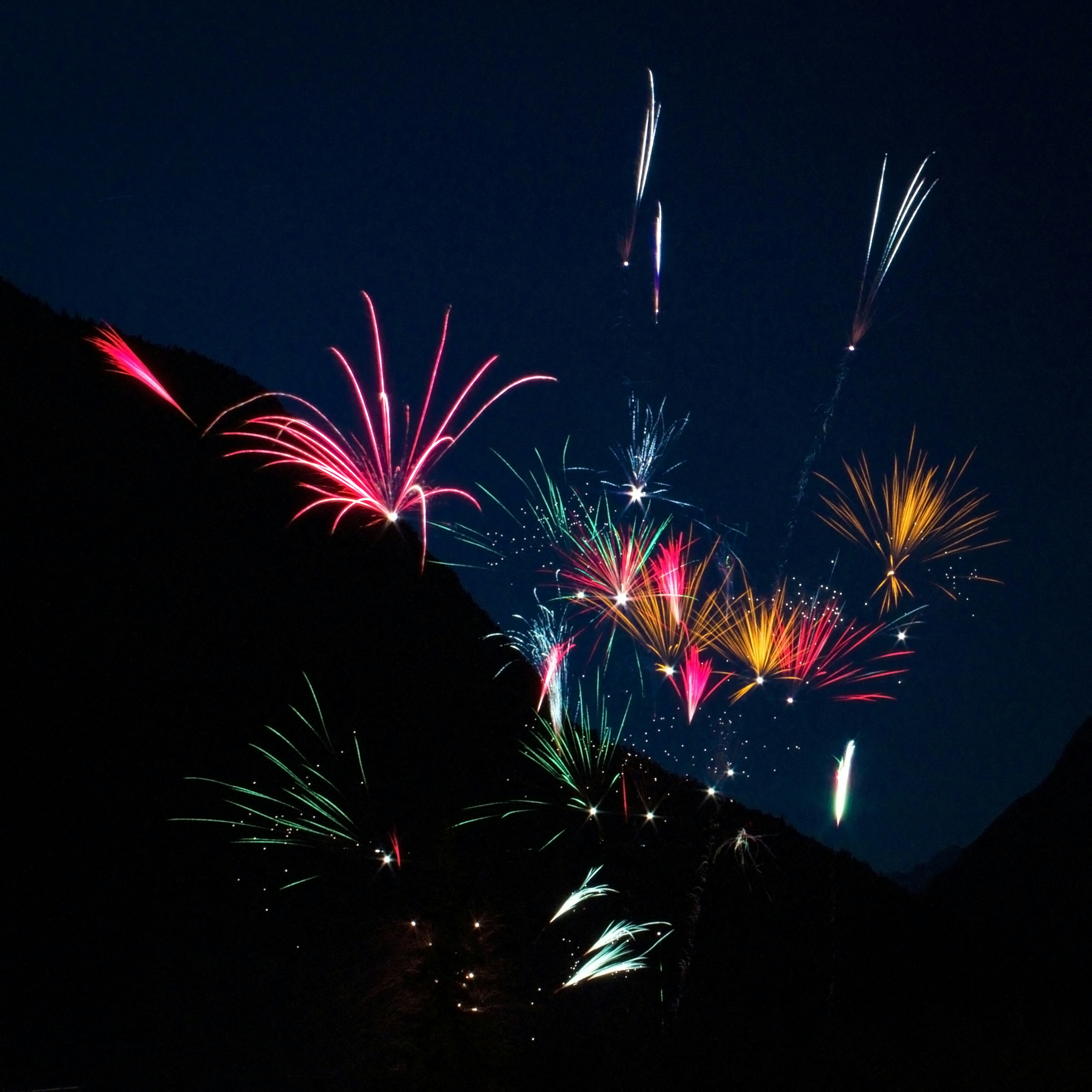 Firework Mosaic Over the Ridge: Colorful Bursts Above the Night Peaks