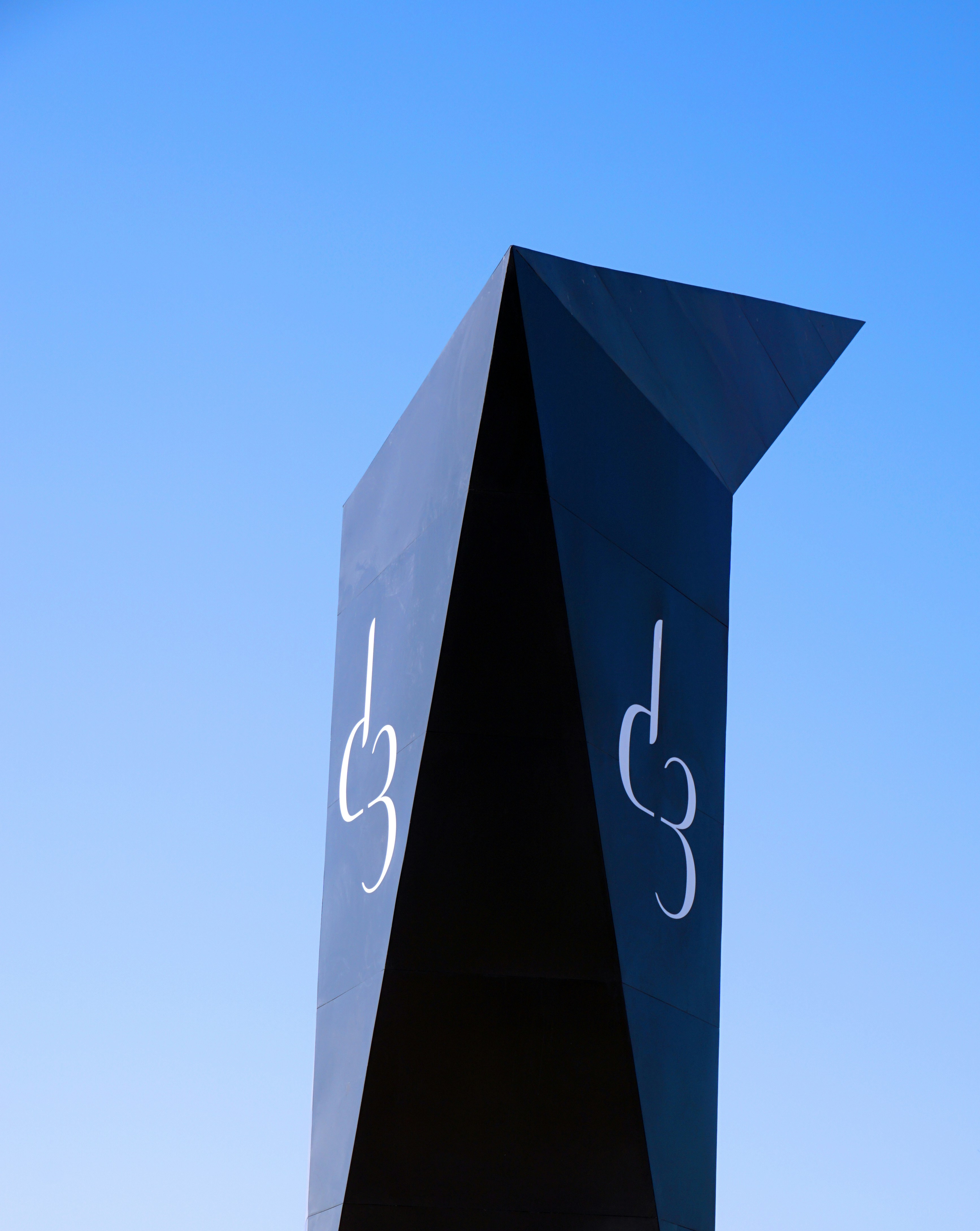 Azure Monolith: An Angular Peak Reaching the Sky
