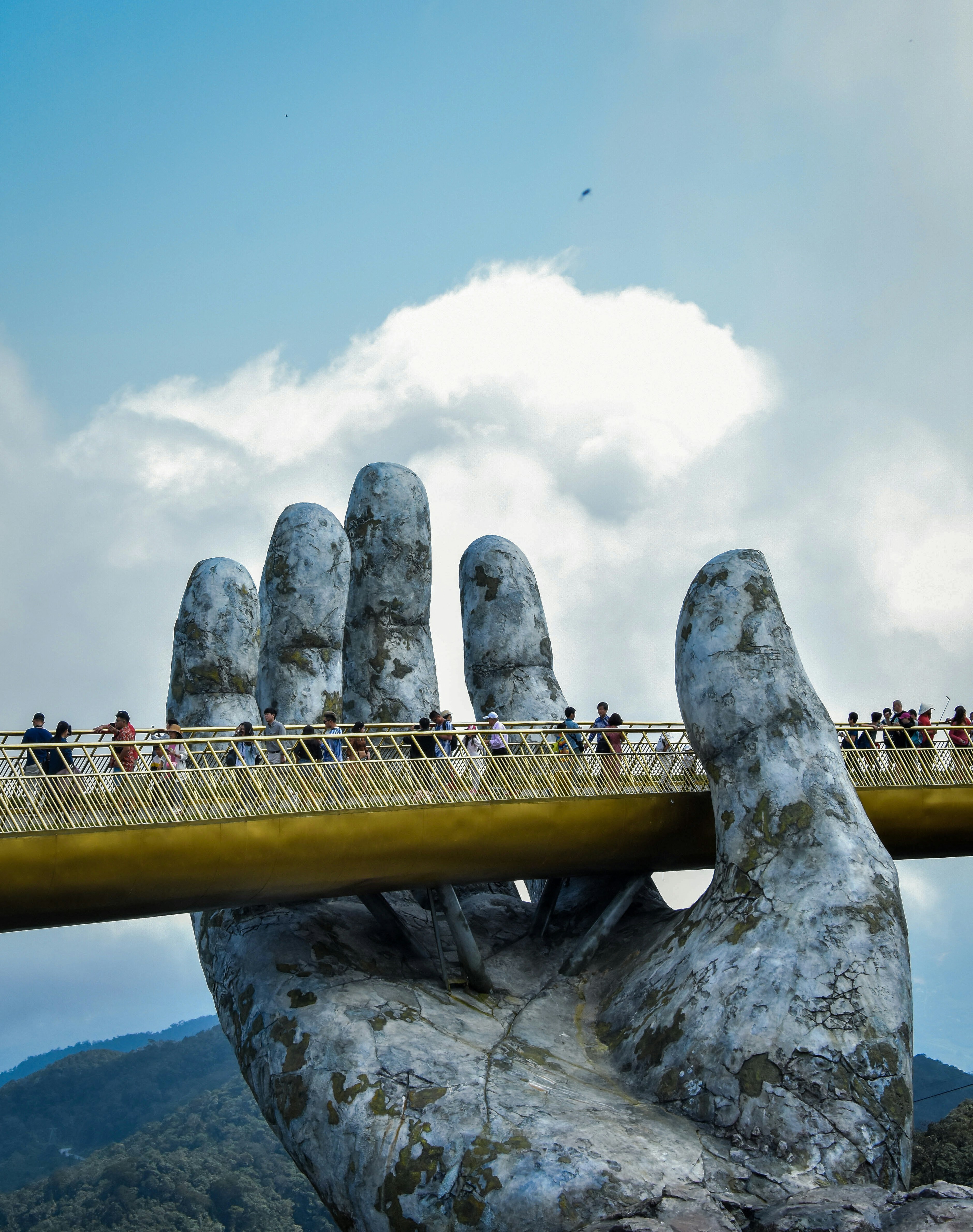 The Hand Bridge: Crowds Traverse a Giant Stone Grasp Above the Valley