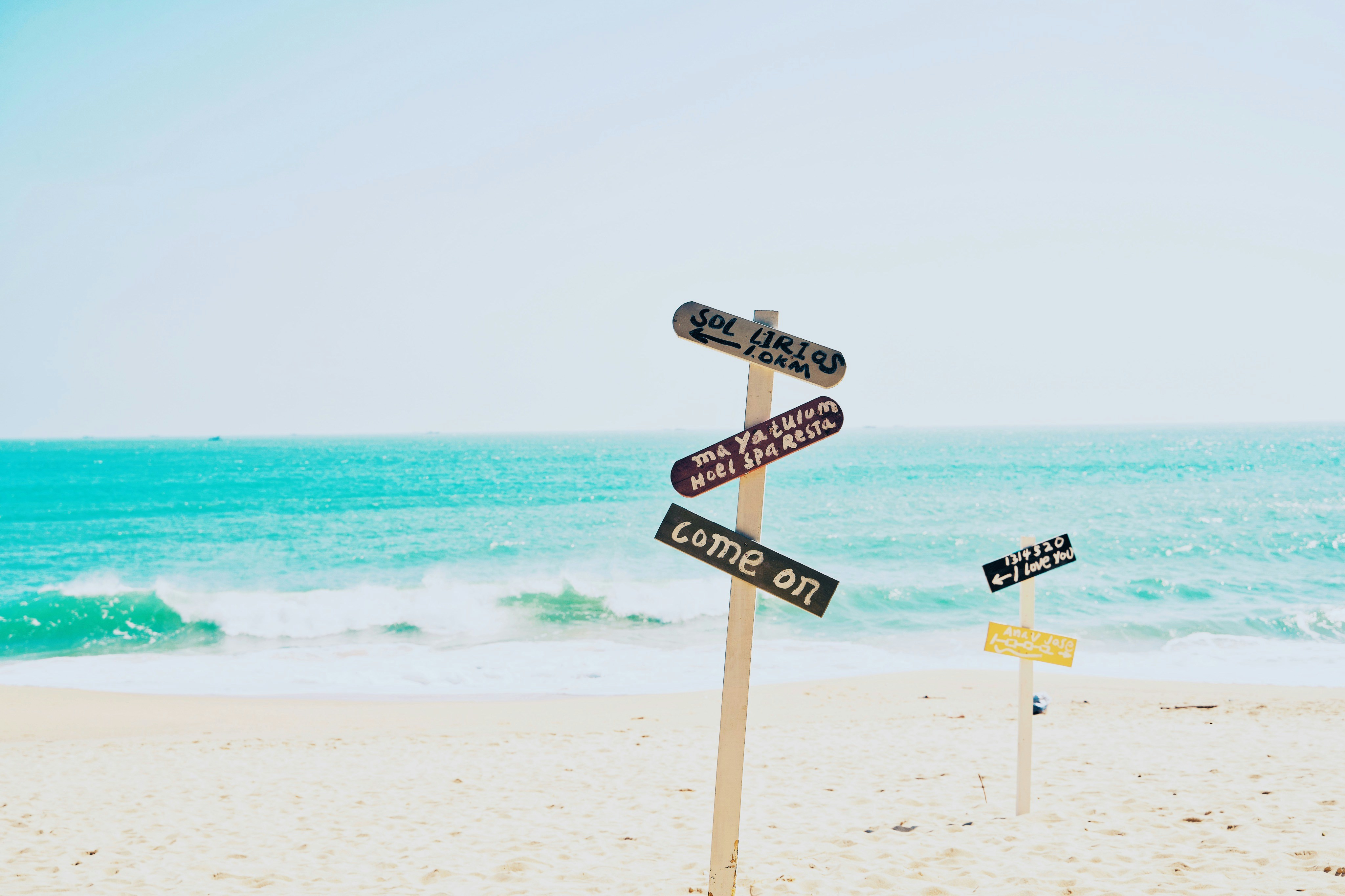 Brown wooden beach signage on beach during daytime photo – Free Blue ...