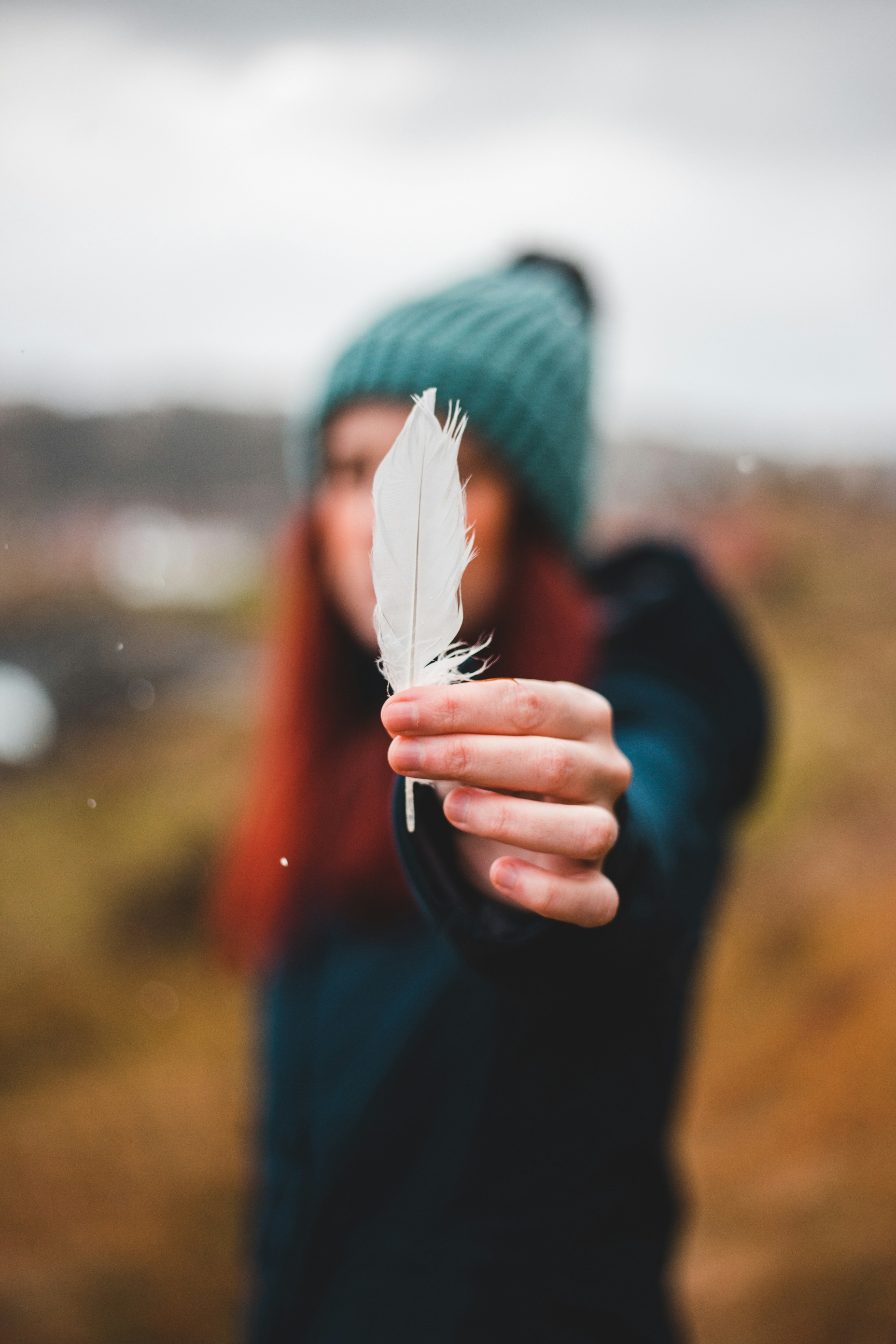 Feather Focus: A Sharp Foreground in a Blur-Kissed Winter Portrait