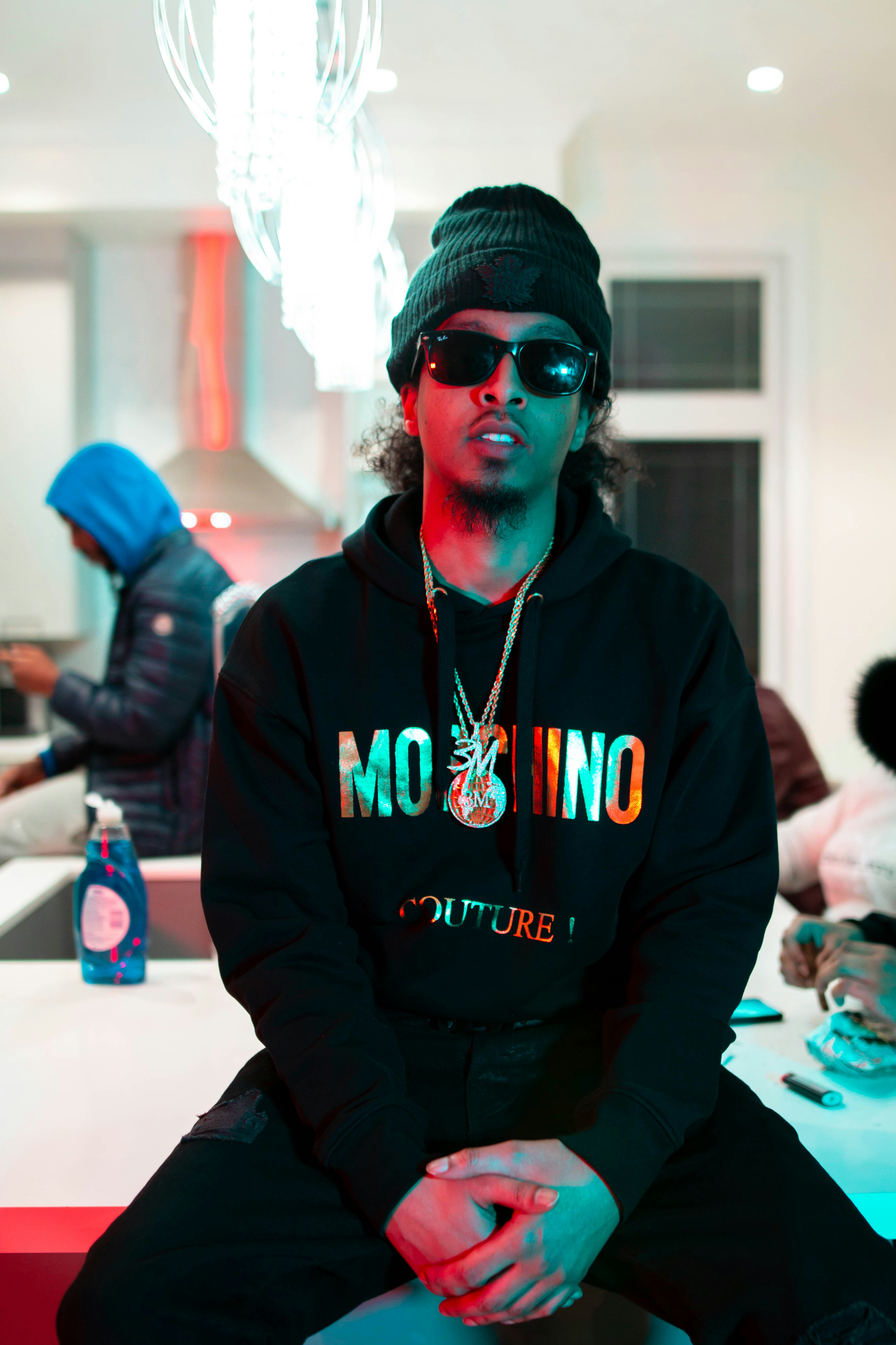 Neon Reflections: Hoodie Confidence Under Kitchen Lights