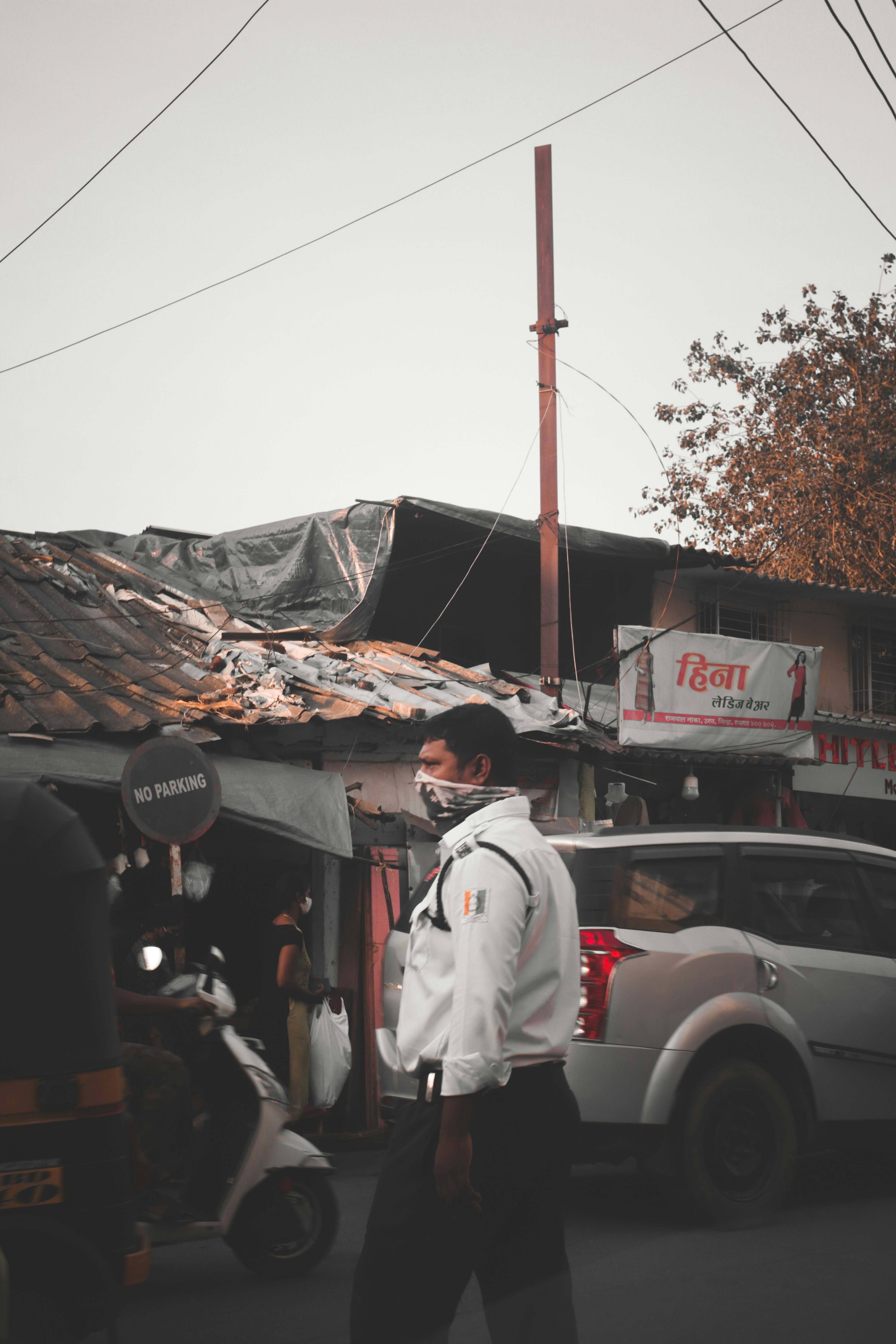 Traffic officer navigating a bustling street scene, surrounded by vehicles and local shops. The backdrop features a mix of urban architecture and signage.