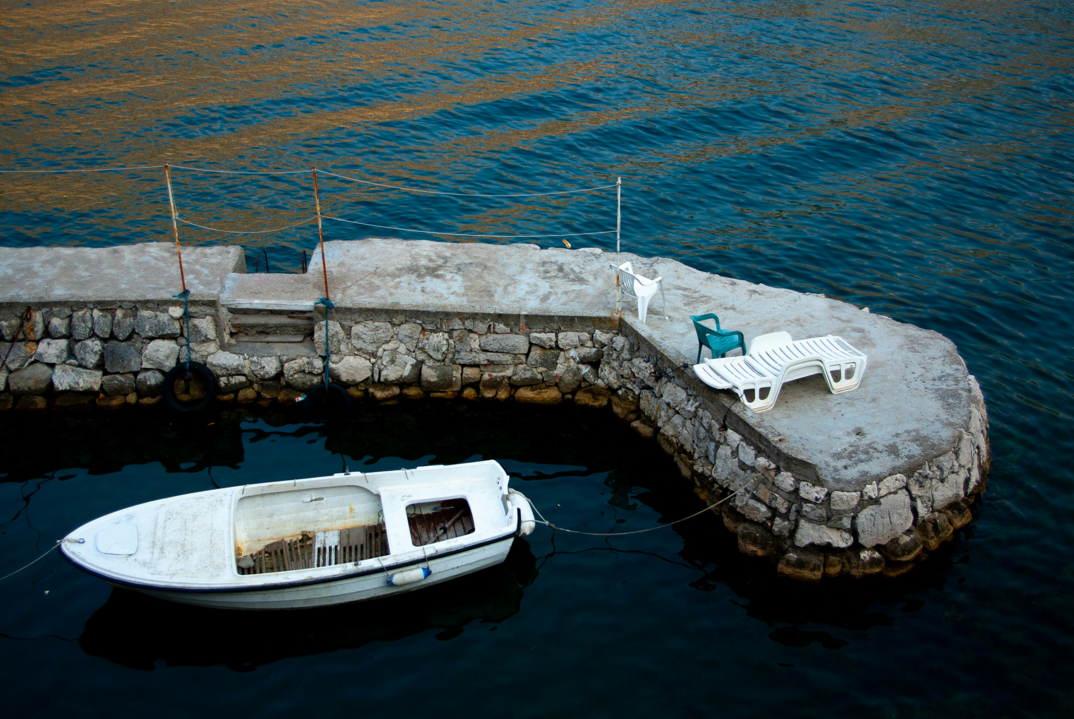 Harbor Geometry: A White Boat at the Stone Pier