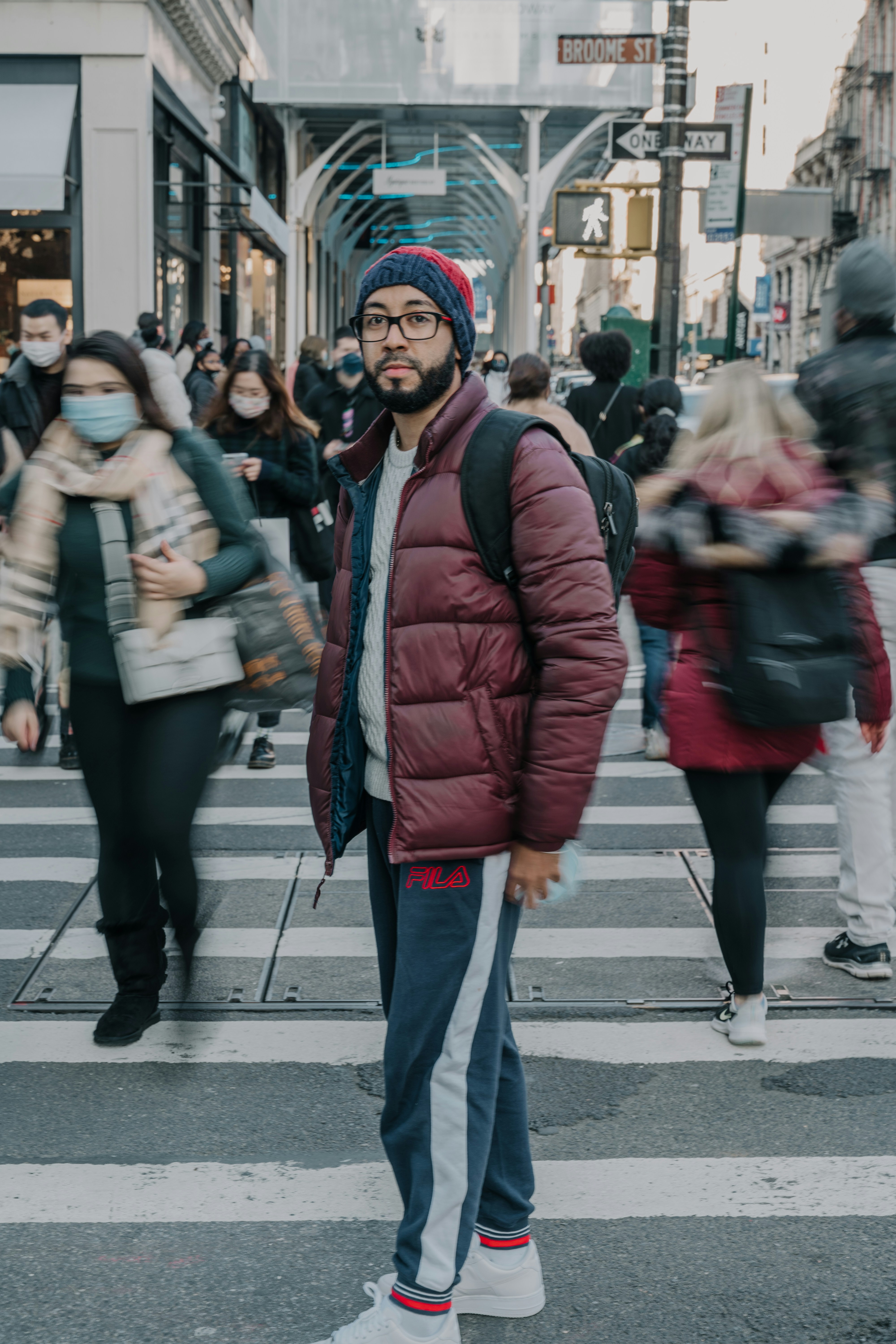 Woman in red bubble jacket standing on pedestrian lane during daytime ...