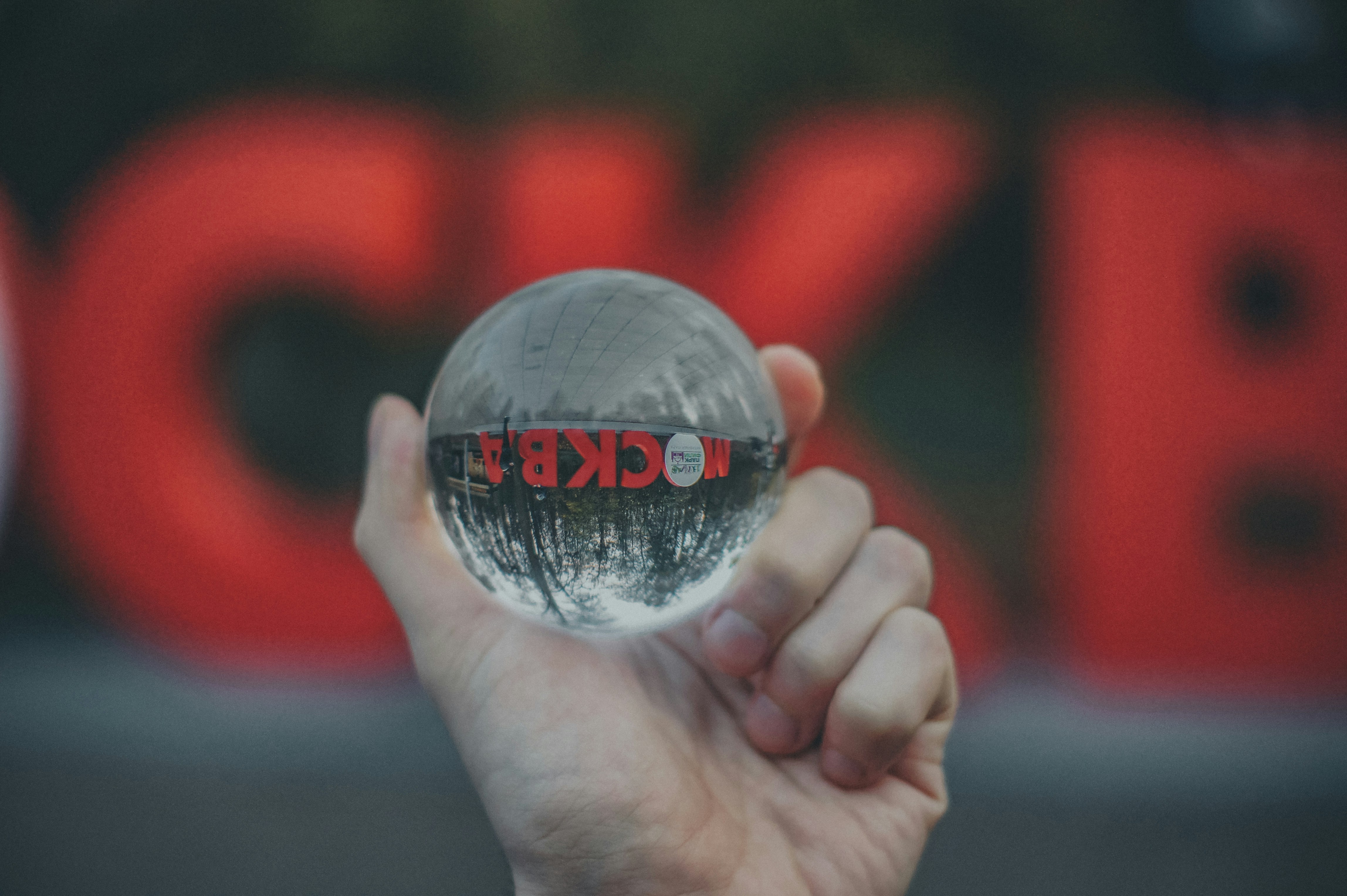 Crystal Sphere of Focus: Handheld Macro with a Red-Logo Backdrop