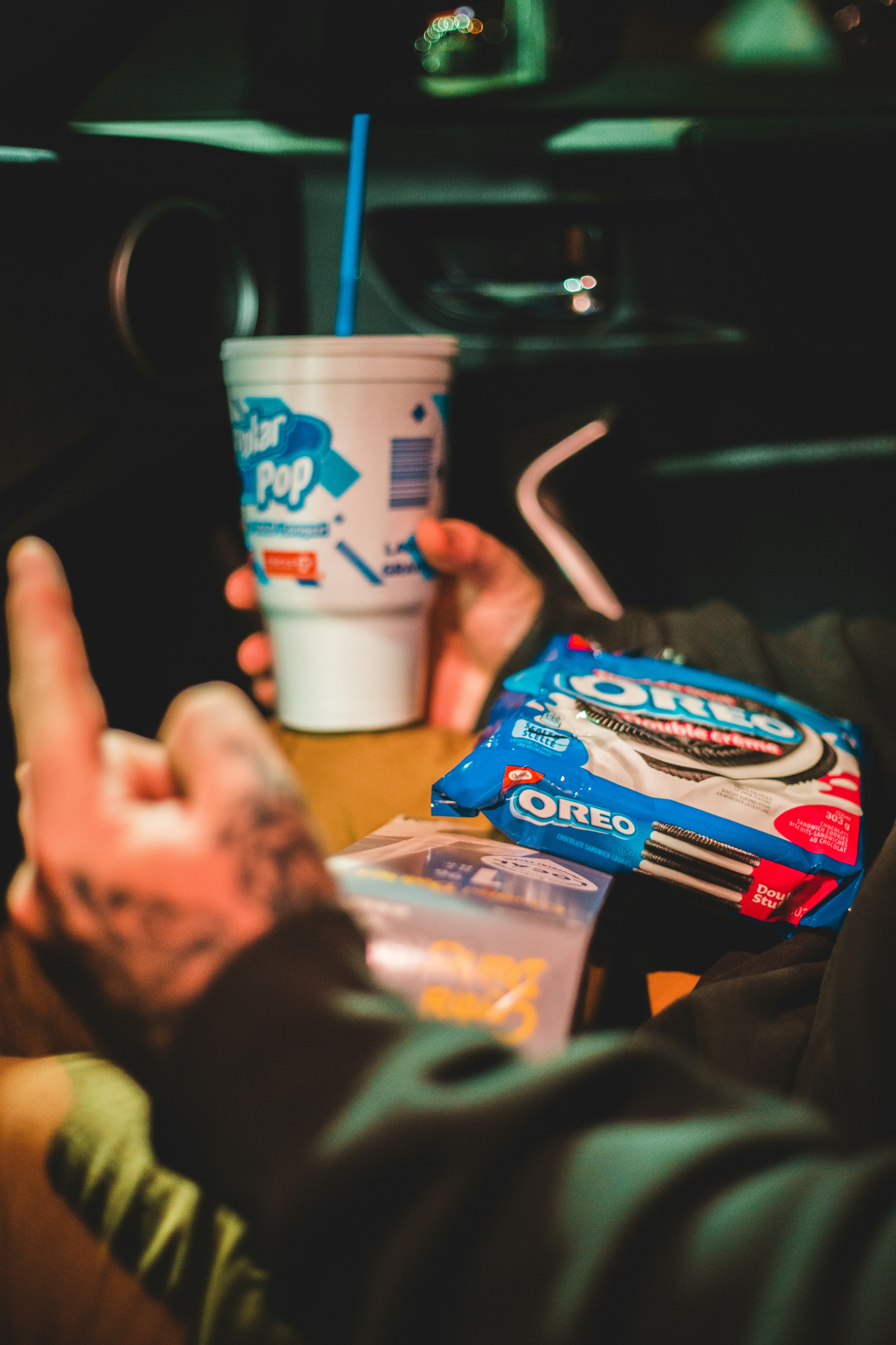 Midnight Snack Break: Oreo Pack and Slushy Cup in the Car Spotlight