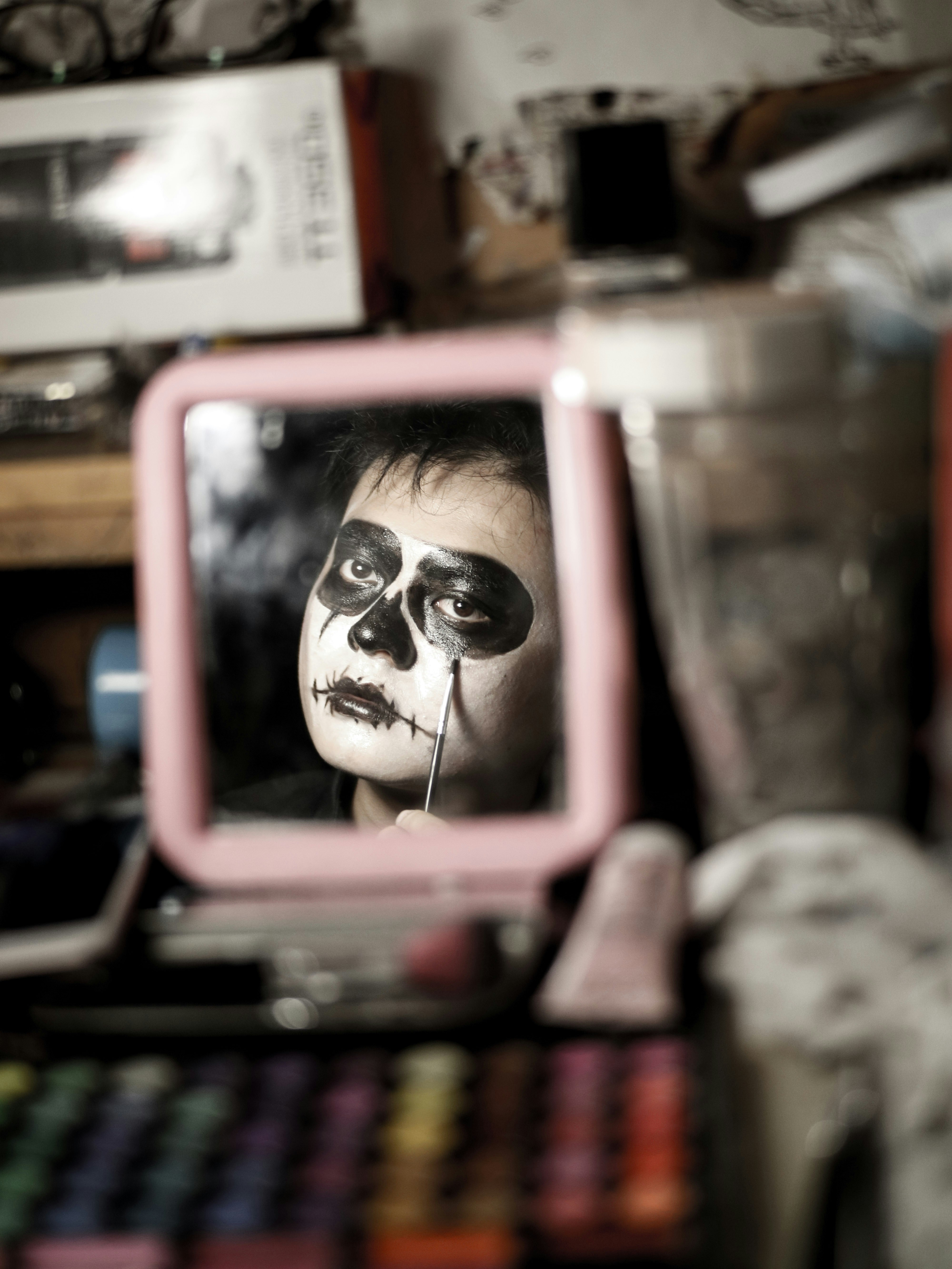 Mirror of Faces: Calavera Makeup Reflected in a Pink Frame