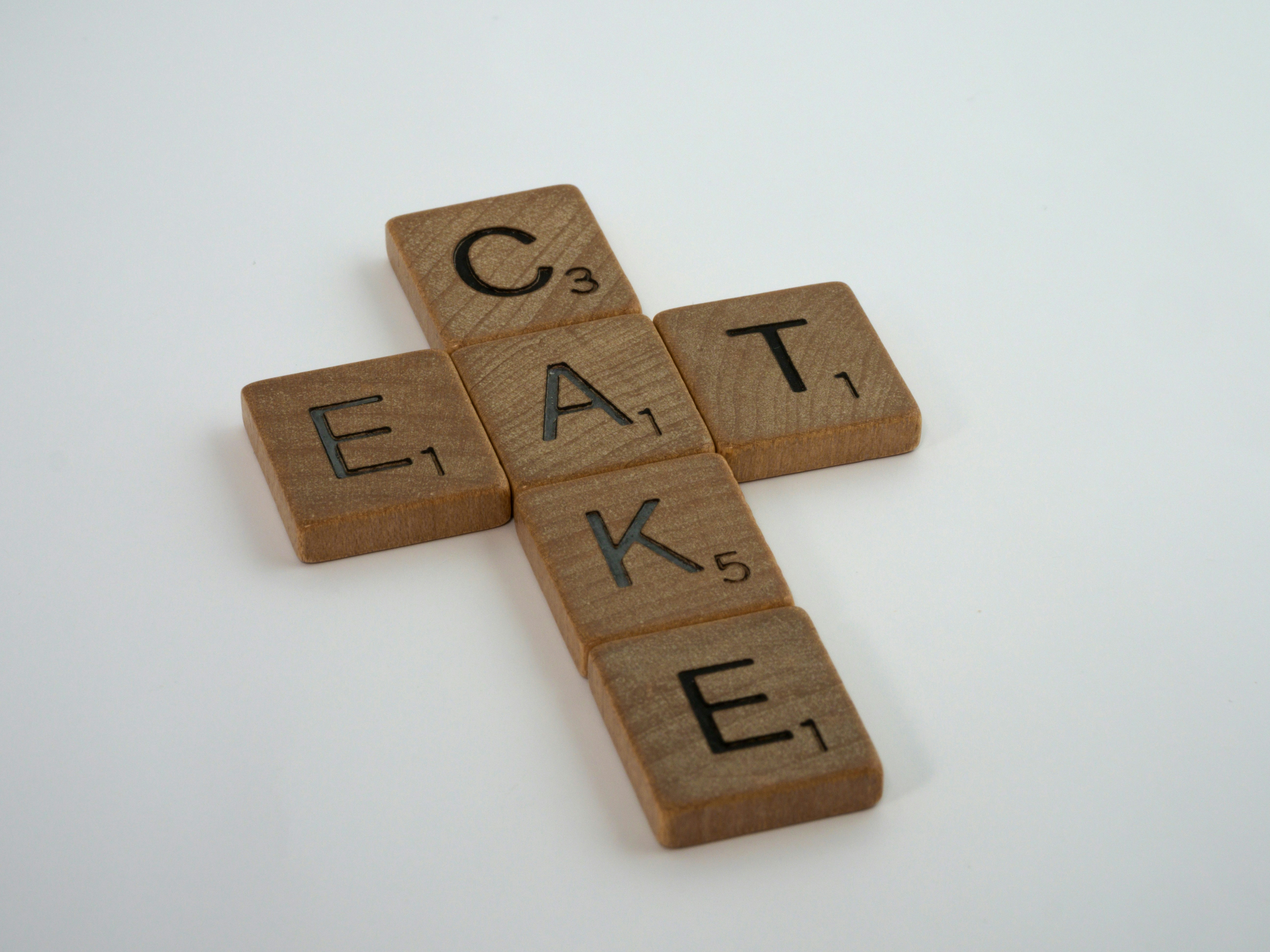 Crossword of Focus: The Word 'TECKE' Formed by Wooden Scrabble Tiles