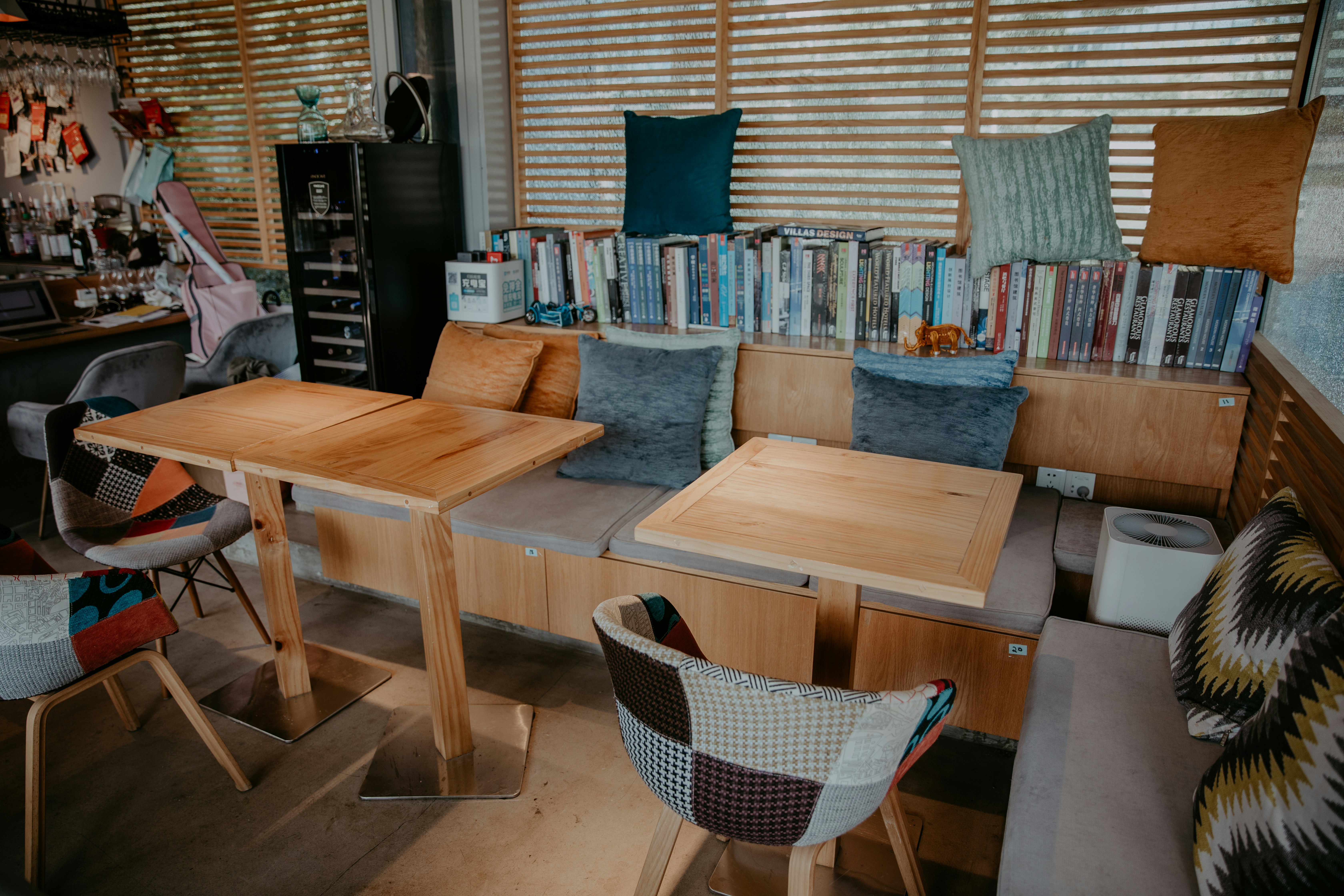 Sunlit Café Nook with Patchwork Chairs and Wooden Tables