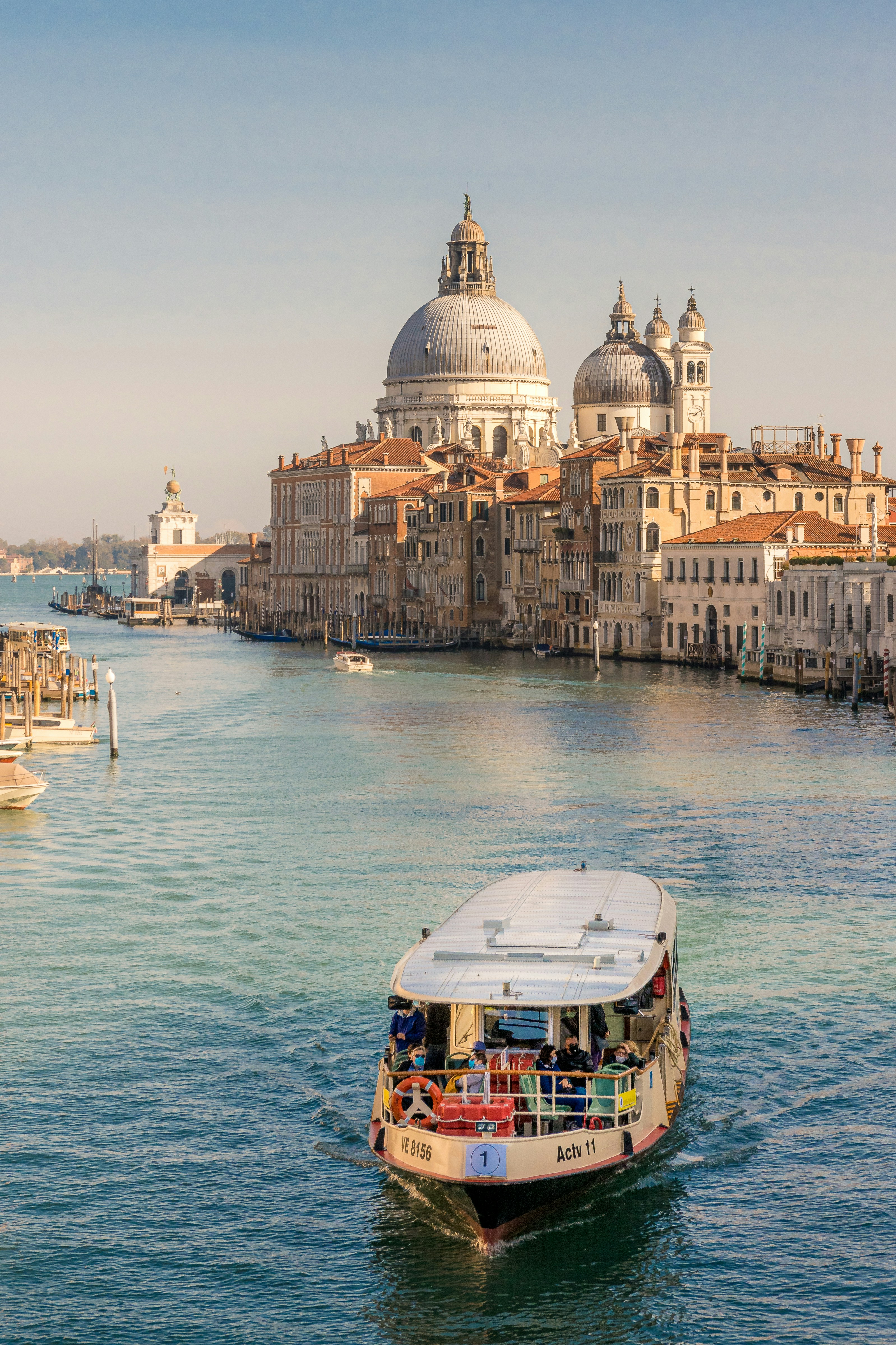 This photo was made, during my stay and visit Venice, Italy with my girlfriend. I've been there many times already, but there is one thing that I can tell you, it's still magical to this day. It's so beautiful each time I go there! I would recommend everyone to go there and visit Venice at least once in their life! | people on boat on water near building during daytime