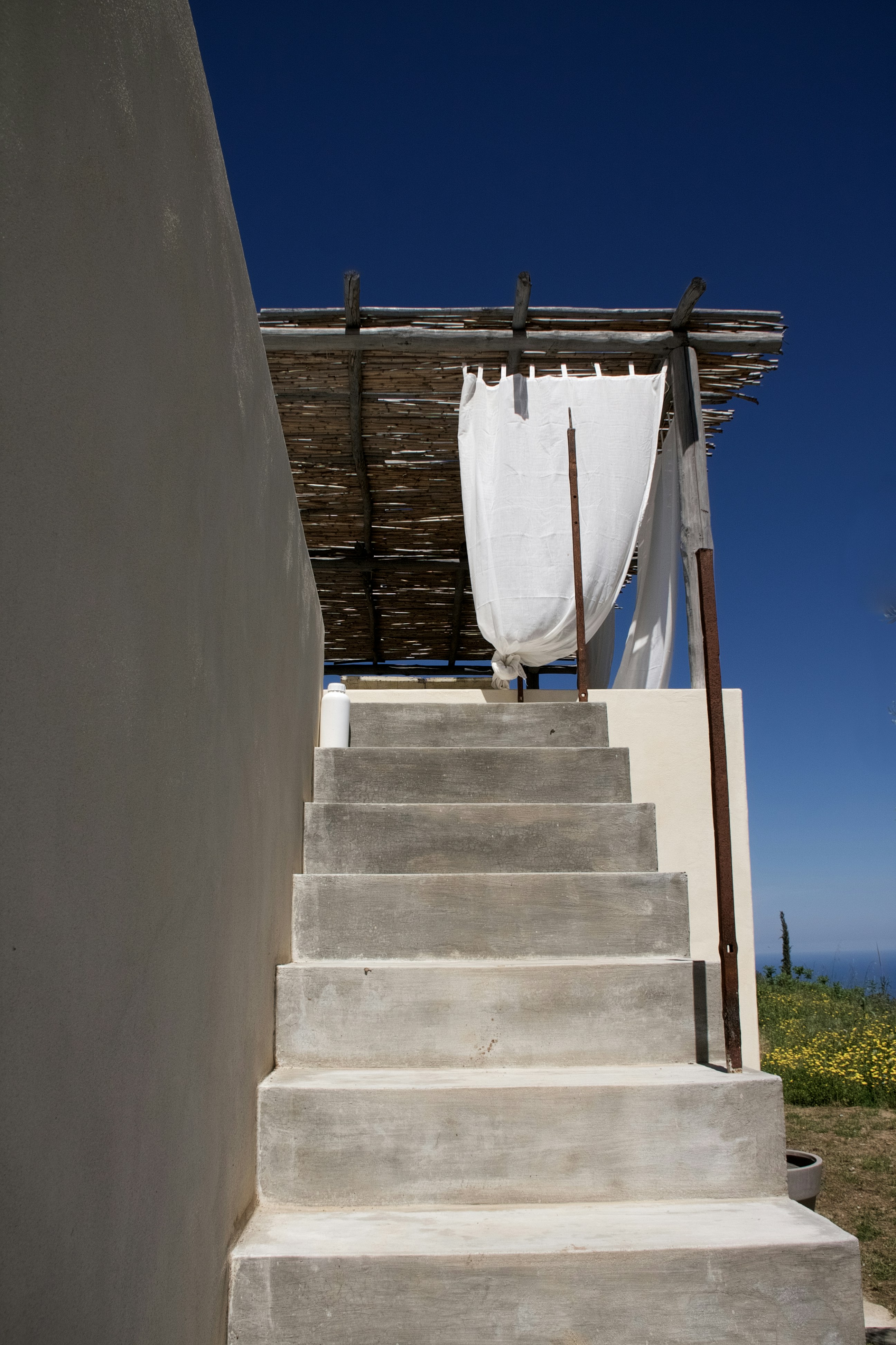 white textile on gray concrete staircase