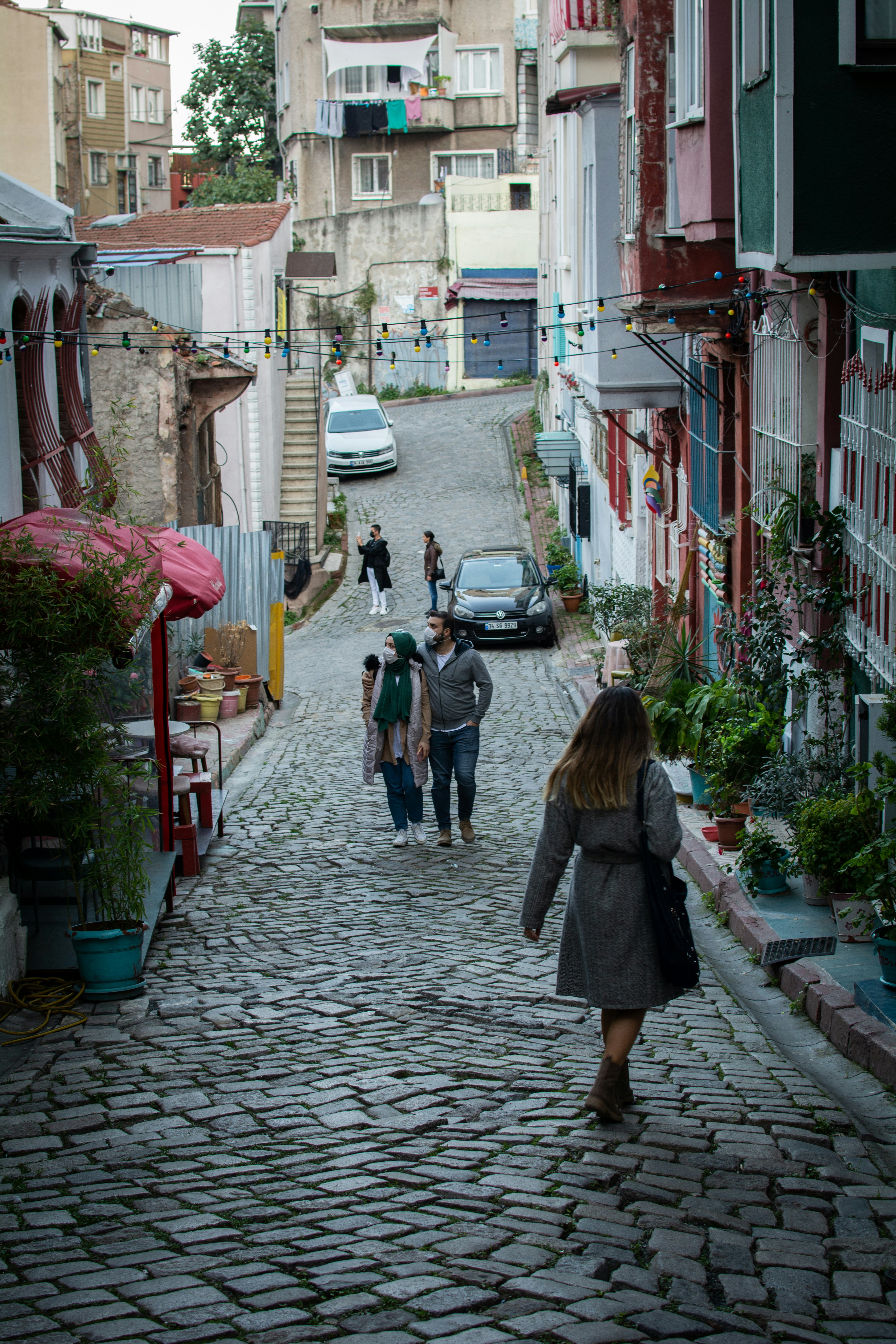 Wanderers on a Cobblestone Street: Life in a Colorful Ramp-way Neighborhood
