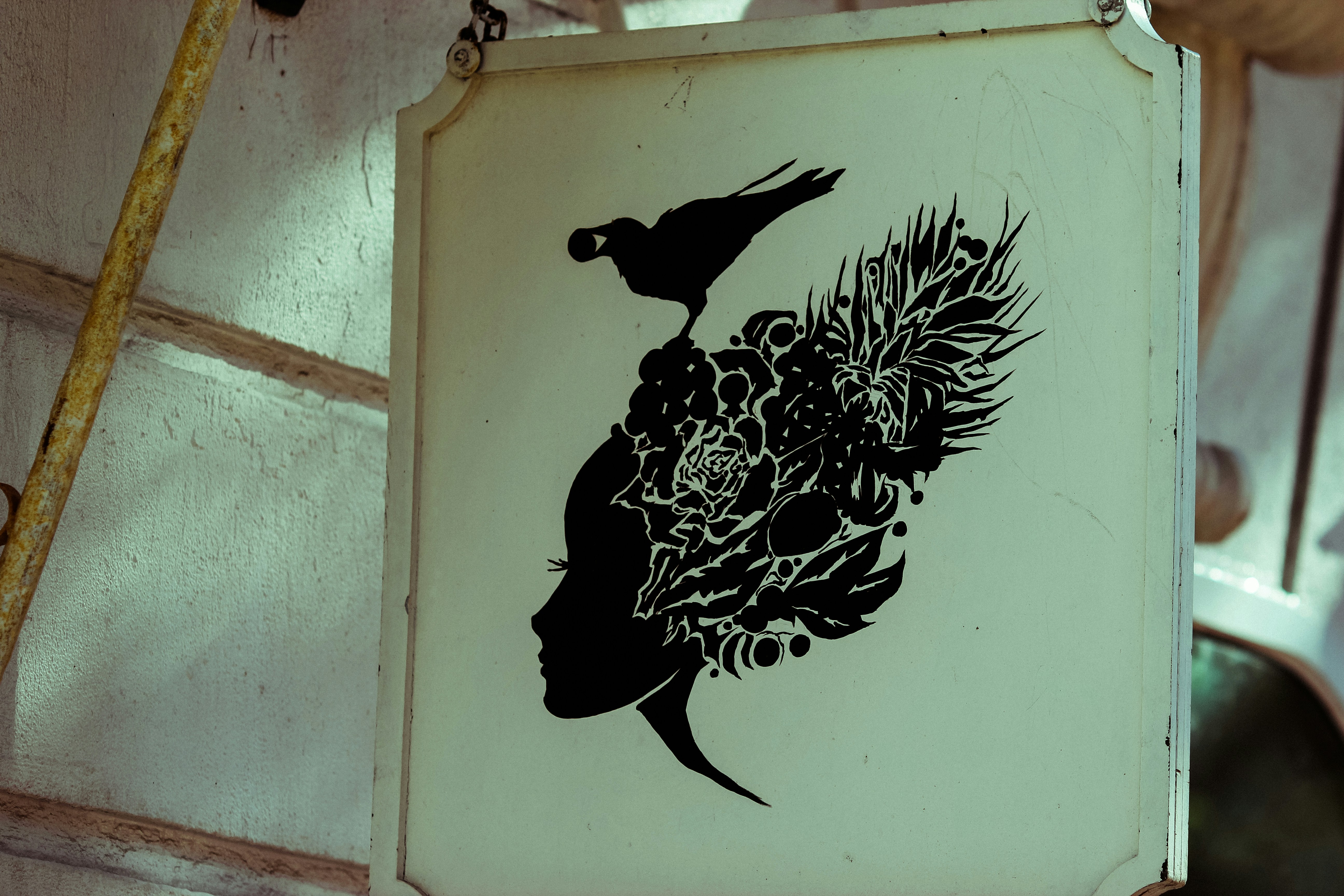 Silhouette of a Profile with Elaborate Headdress on a Light Panel