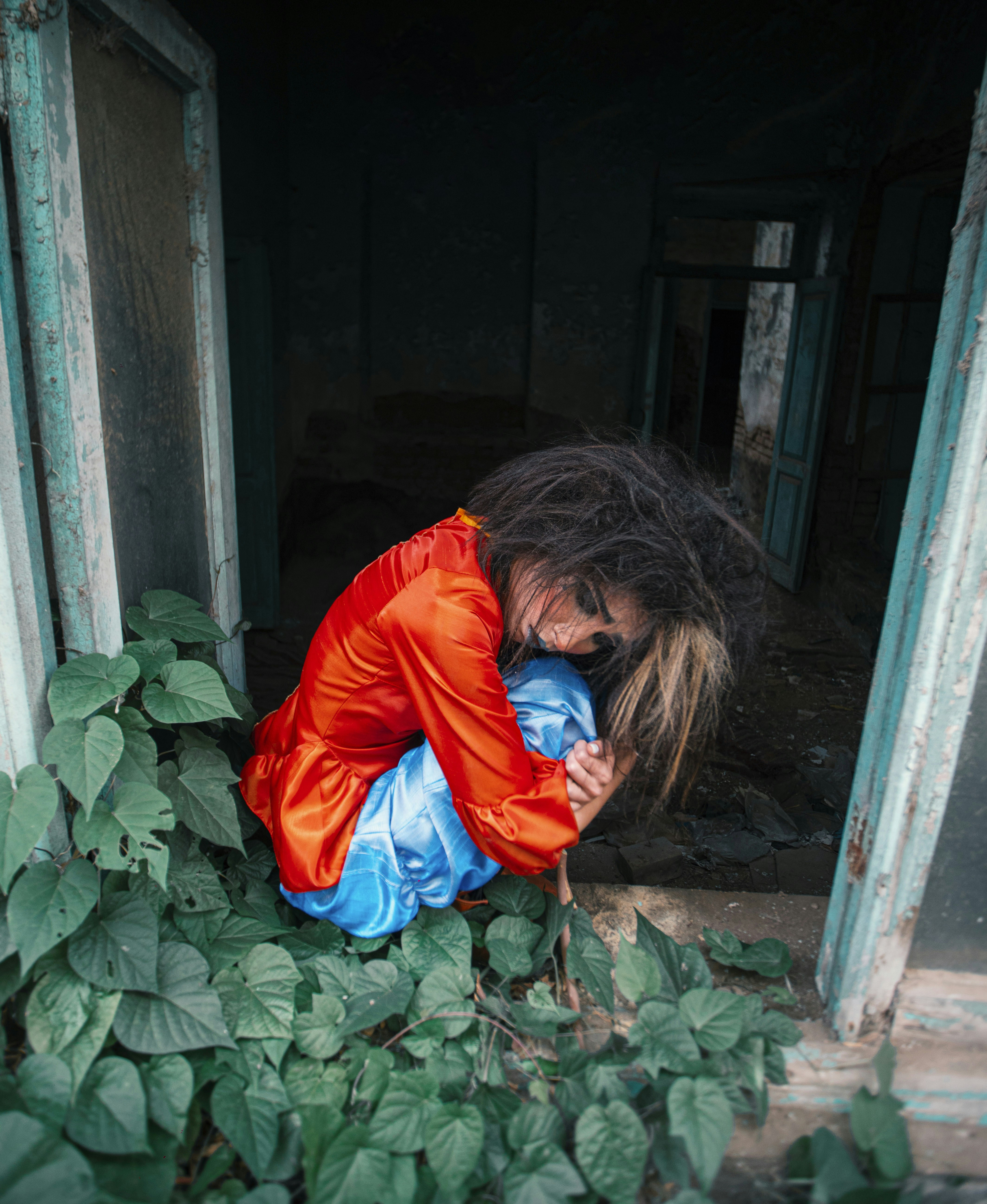 Threshold of Quiet: A Red Coat by an Ivy-Guarded Doorway