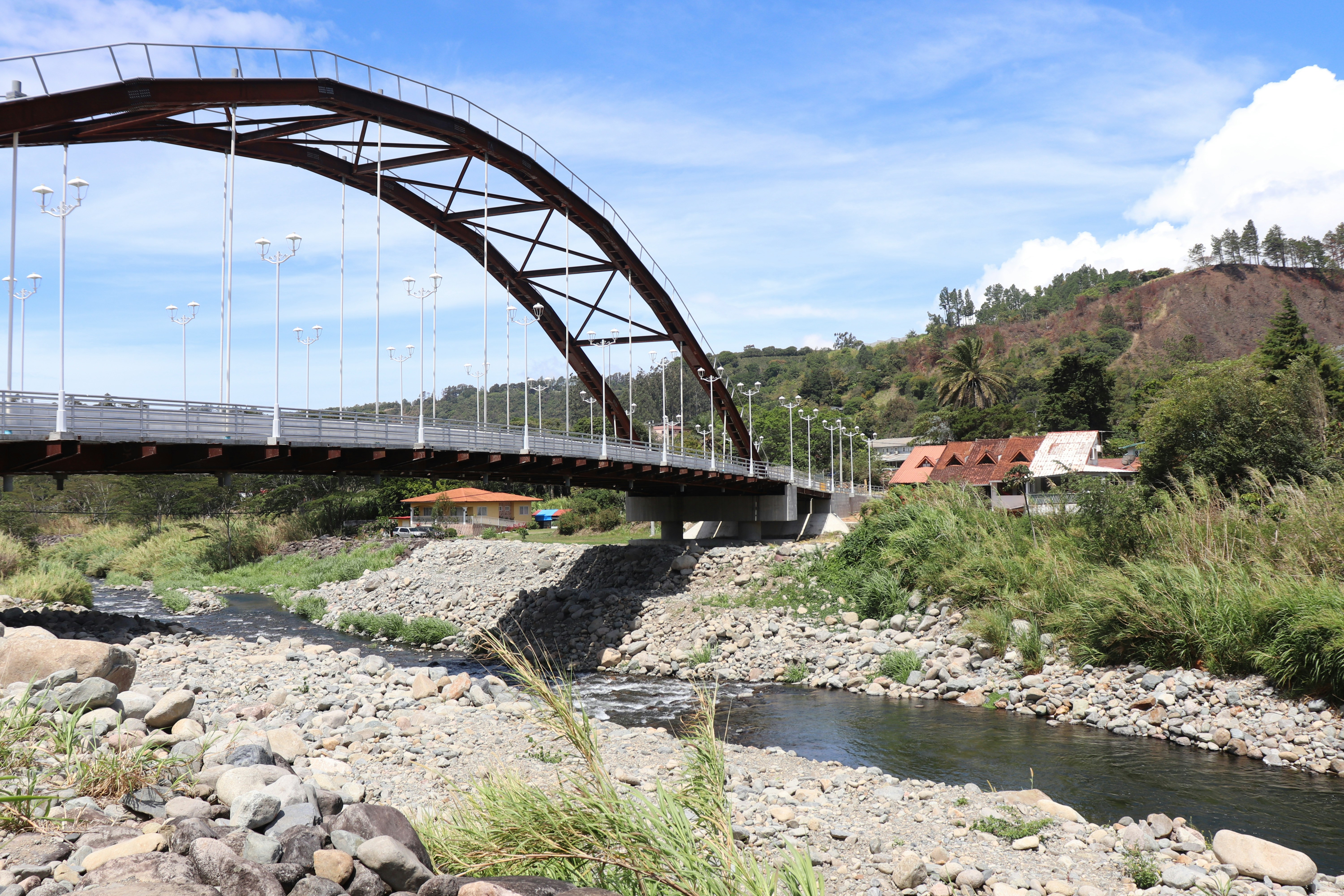 Gray bridge over river under blue sky during daytime photo – Free ...