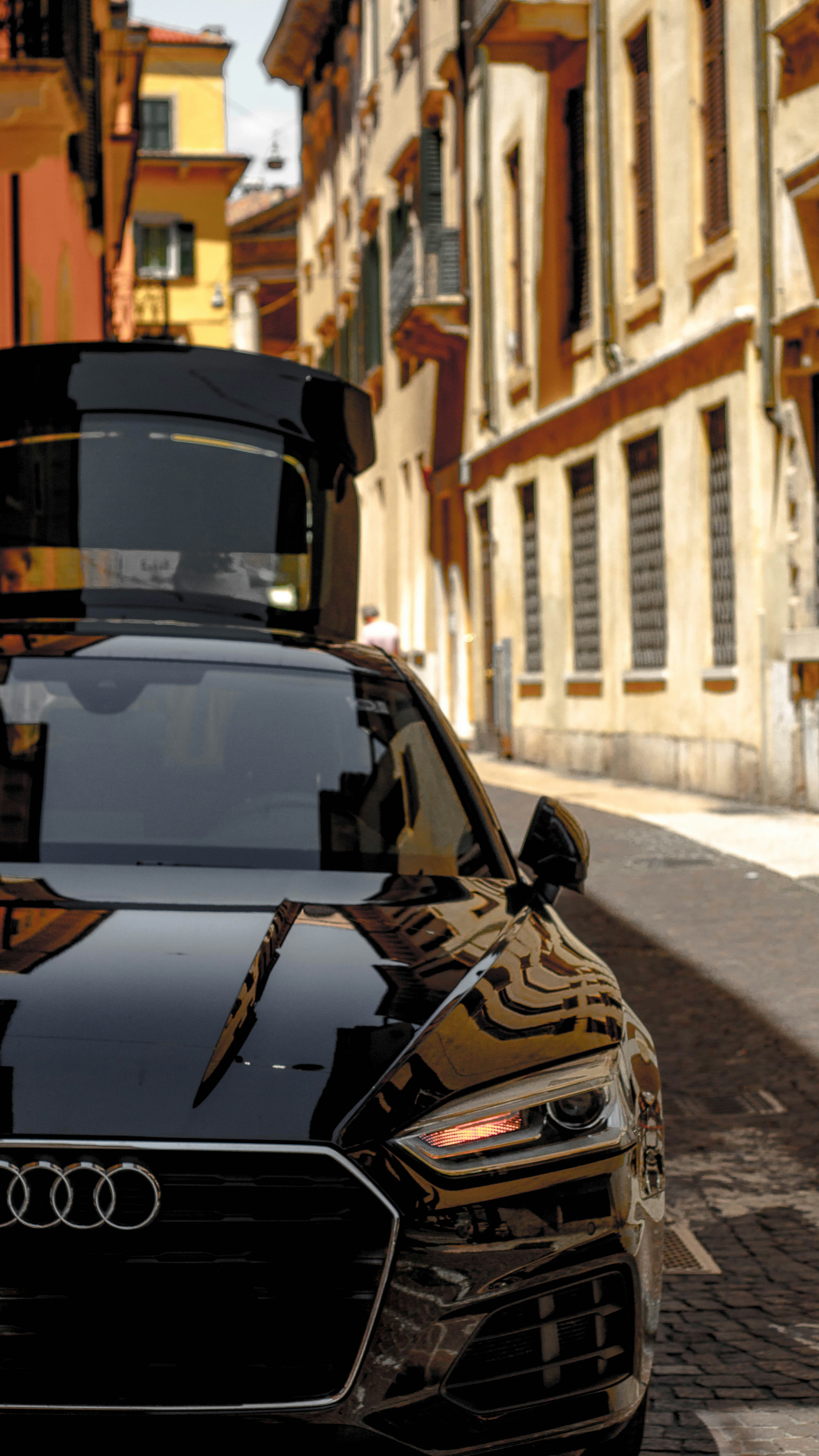 Noir on Cobblestones: An Audi Commands a Sunlit European Street