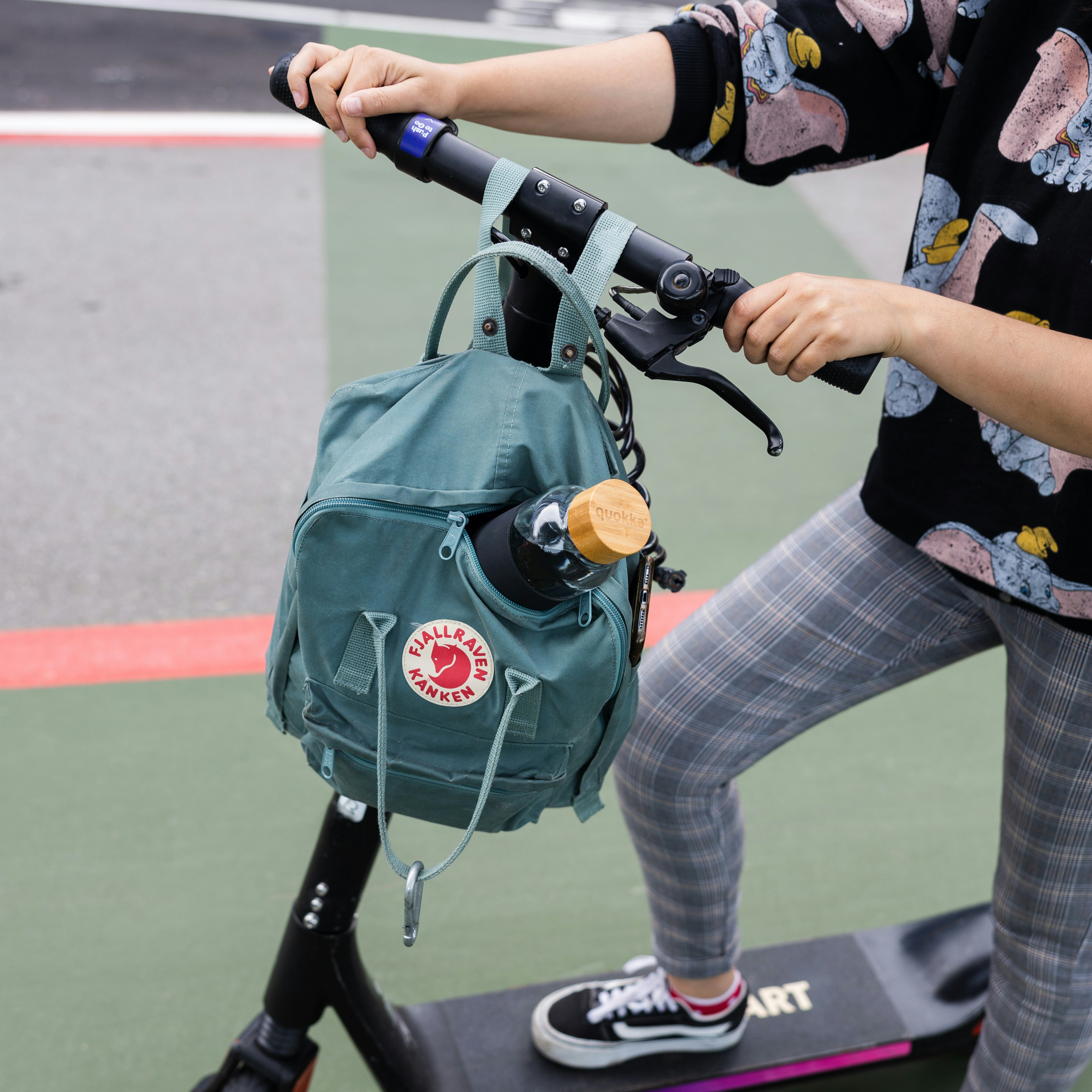 Teal Fjällräven Backpack Anchors a City Scooter Ride