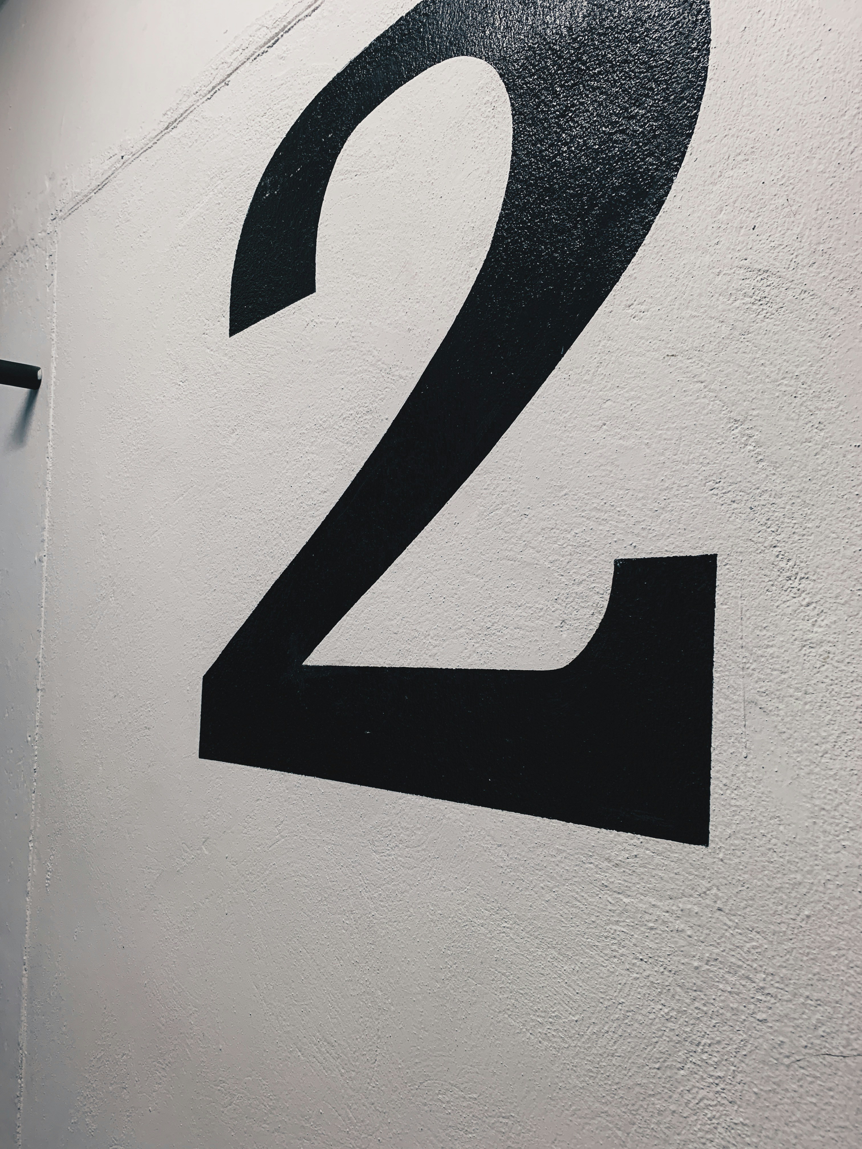 Two on a Rough Canvas: Close-Up of a Bold Numeral