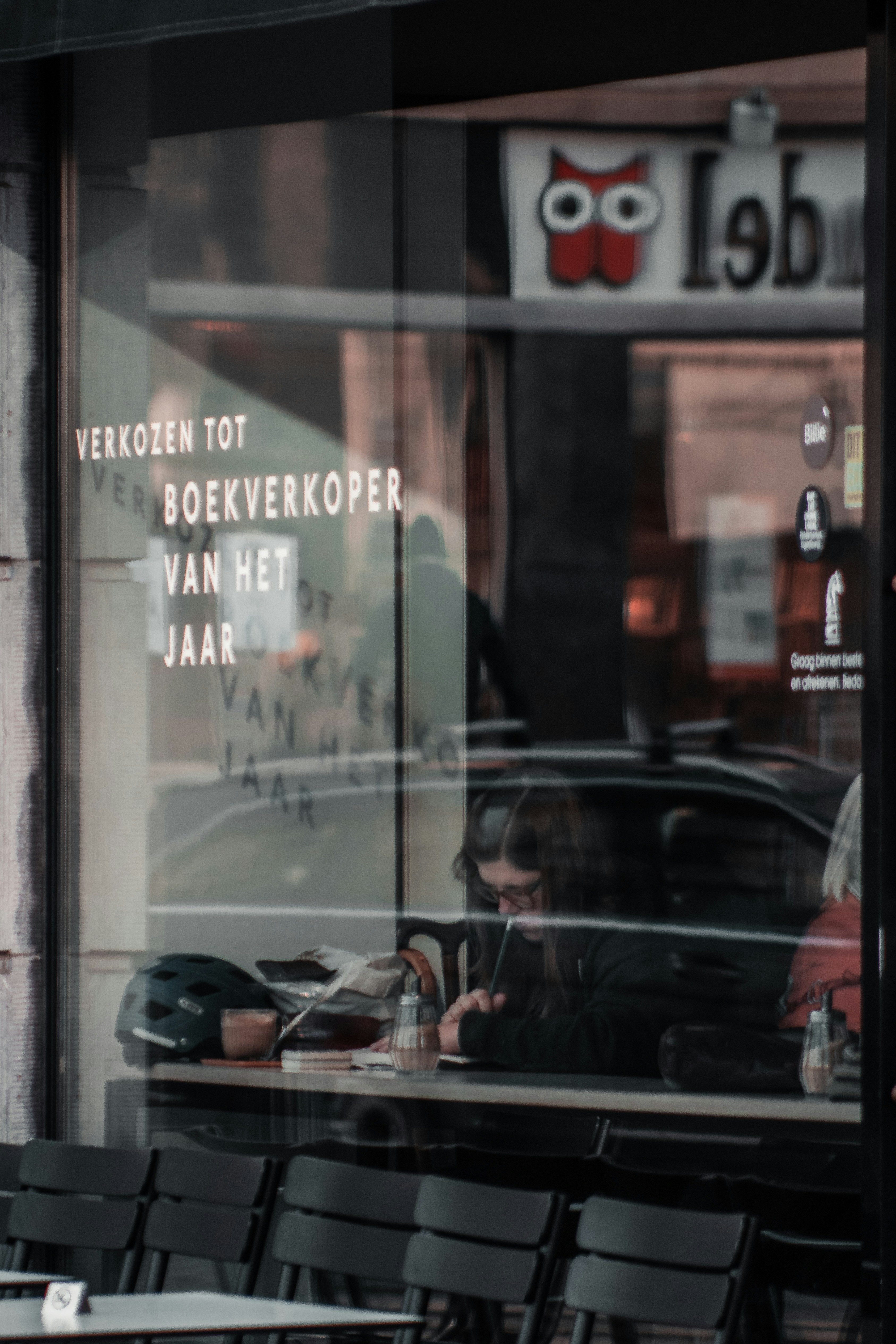 Quiet Focus Inside a Glass-Walled Café