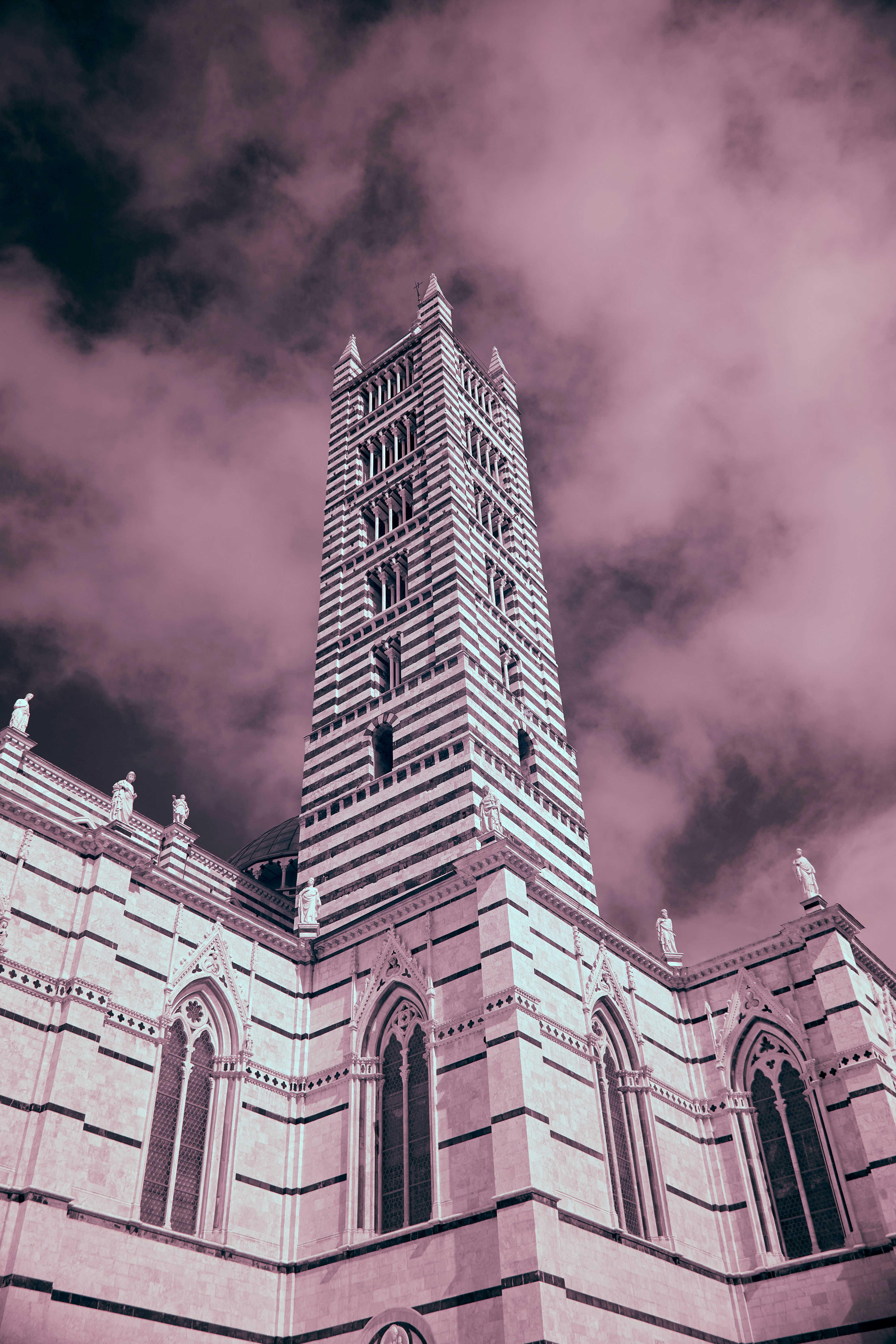 Lilac Spire: A Gothic Tower Crowned by Pink Clouds