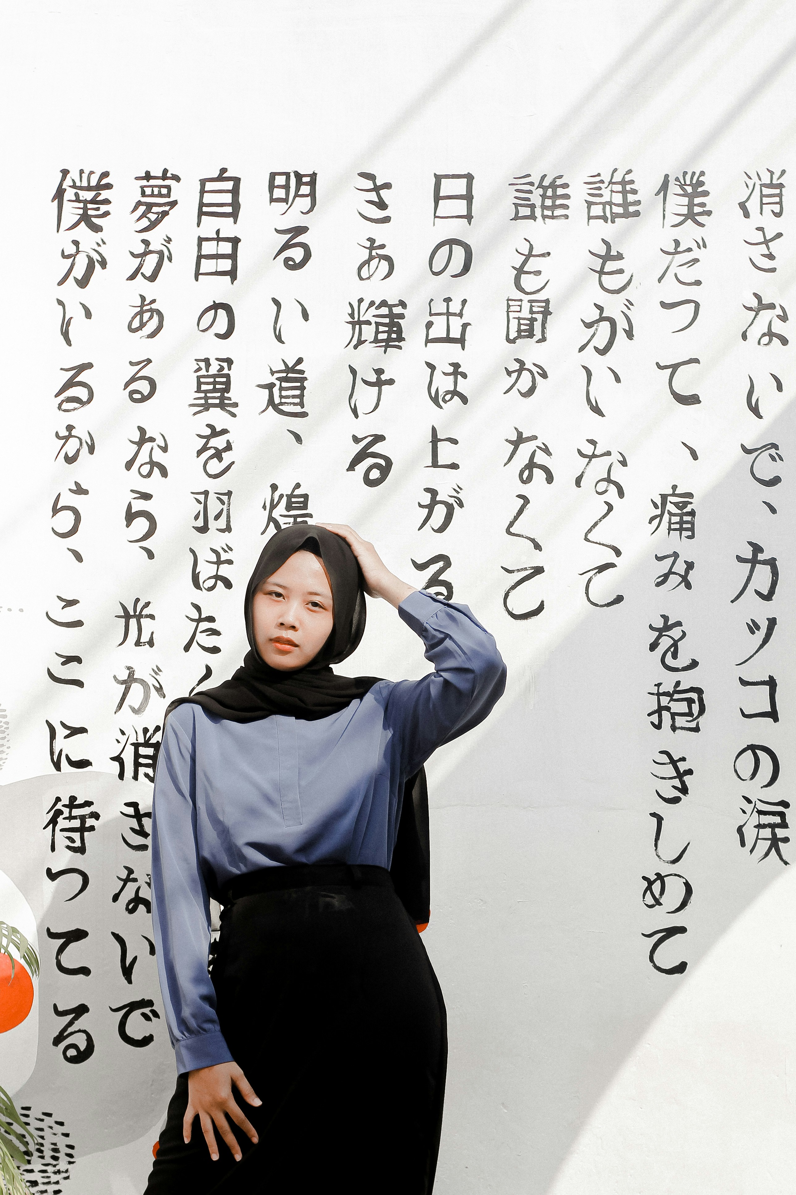 Portrait in Front of a Cascade of Kanji: Calm Presence Amid Vertical Script