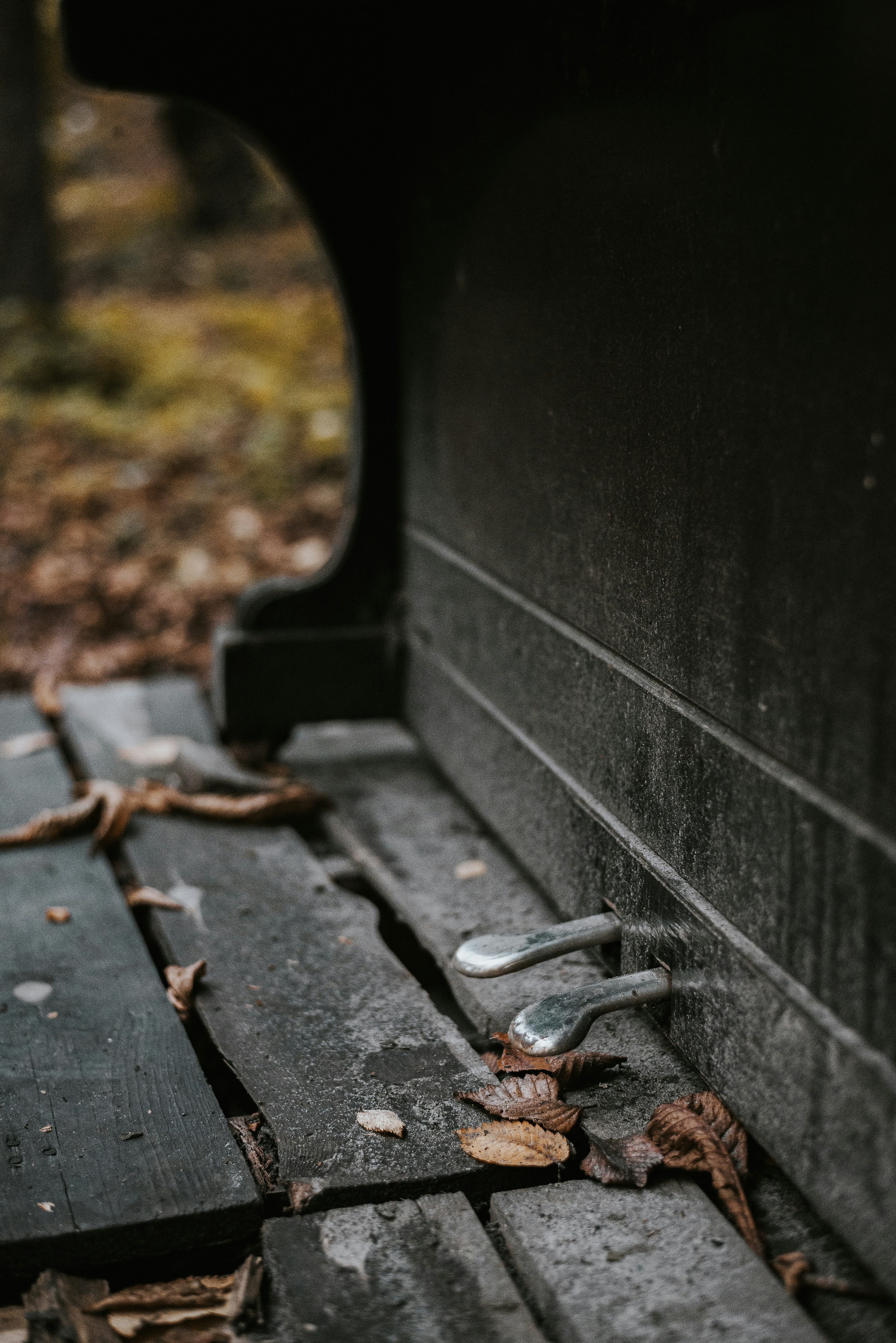 black metal tool on black wooden fence