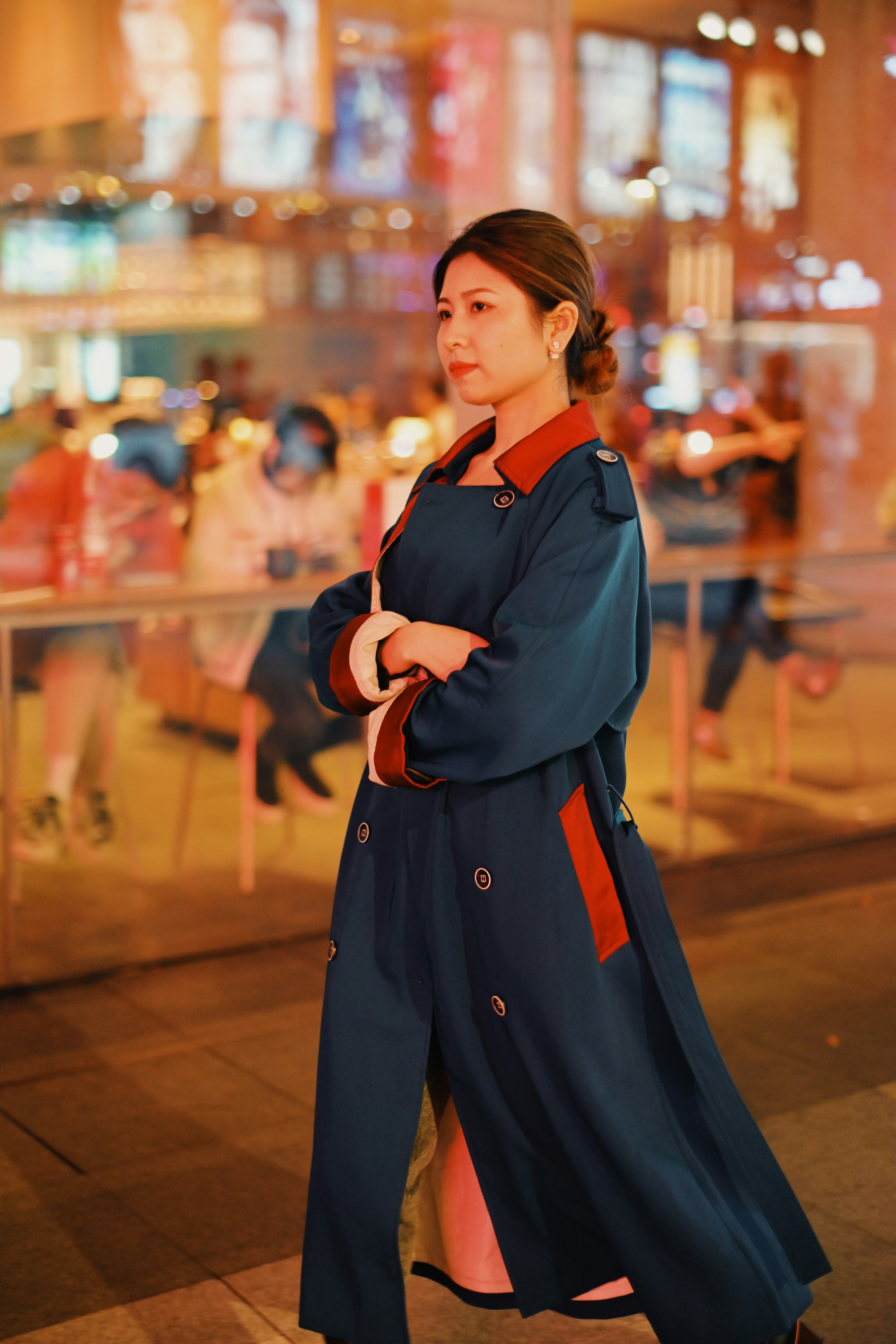 Neon Quiet: A Woman in a Navy Trench Under City Lights