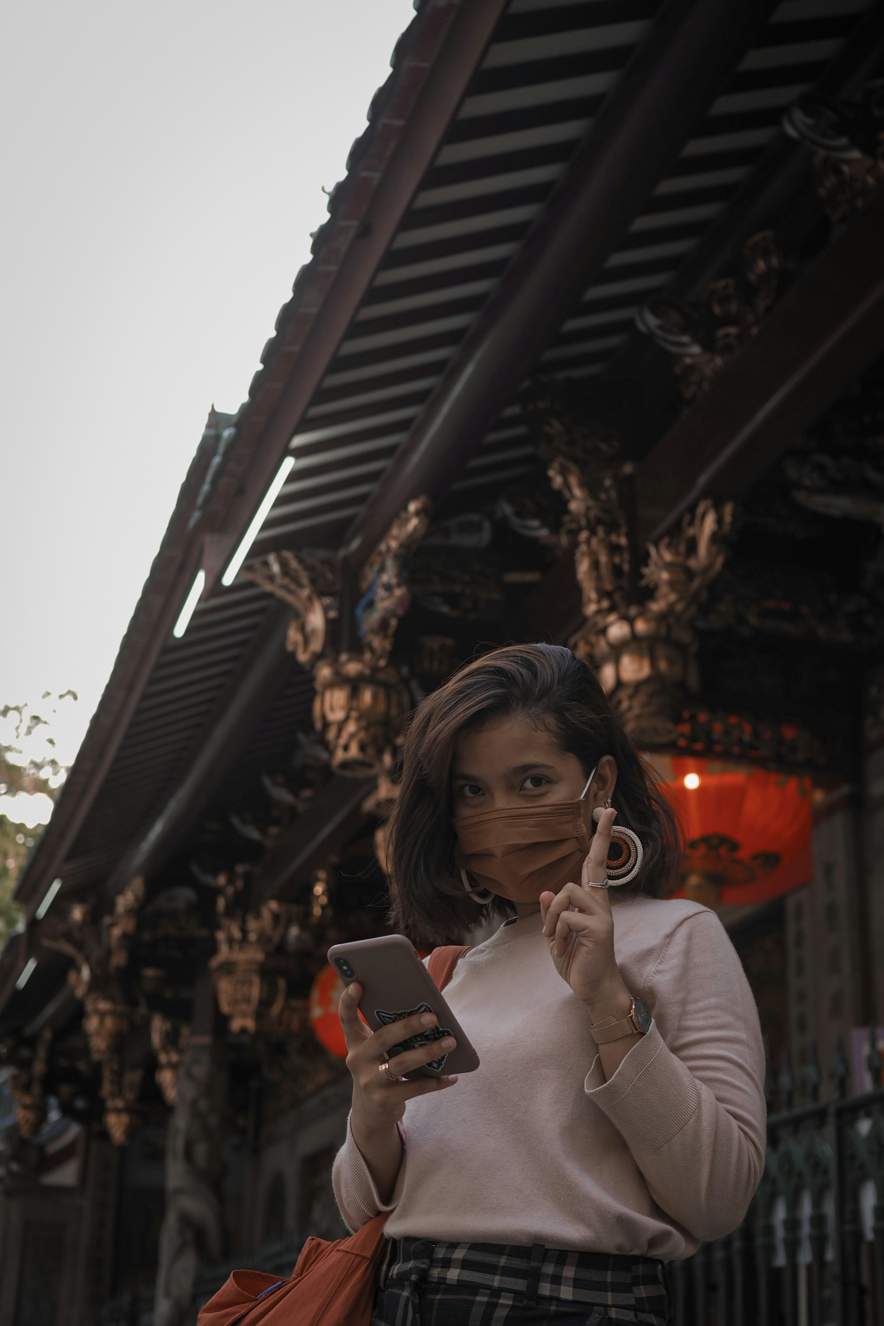 Masked Moment by the Carved Temple: Portrait in Lantern Glow