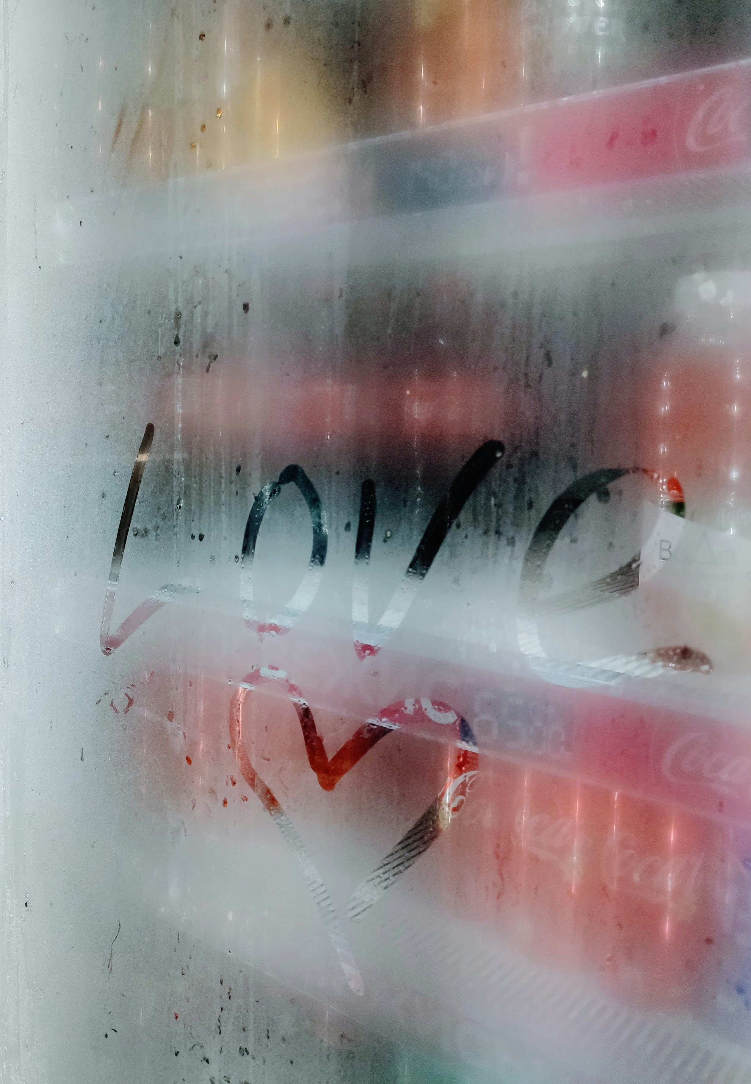 Love in Frosted Glass: A Coca-Cola Heart Through a Steamy Window