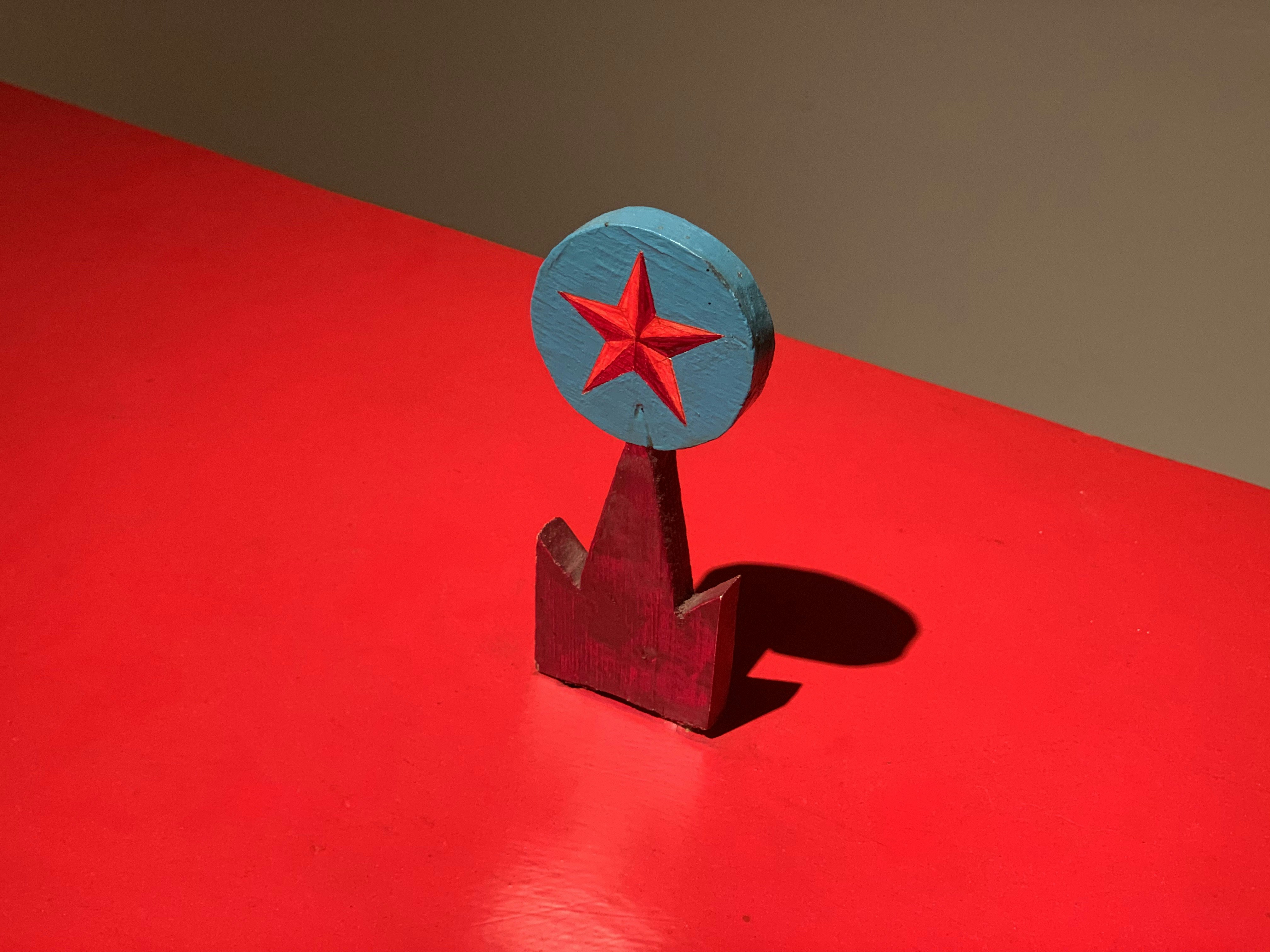 Blue Star Crest on a Crimson Stage