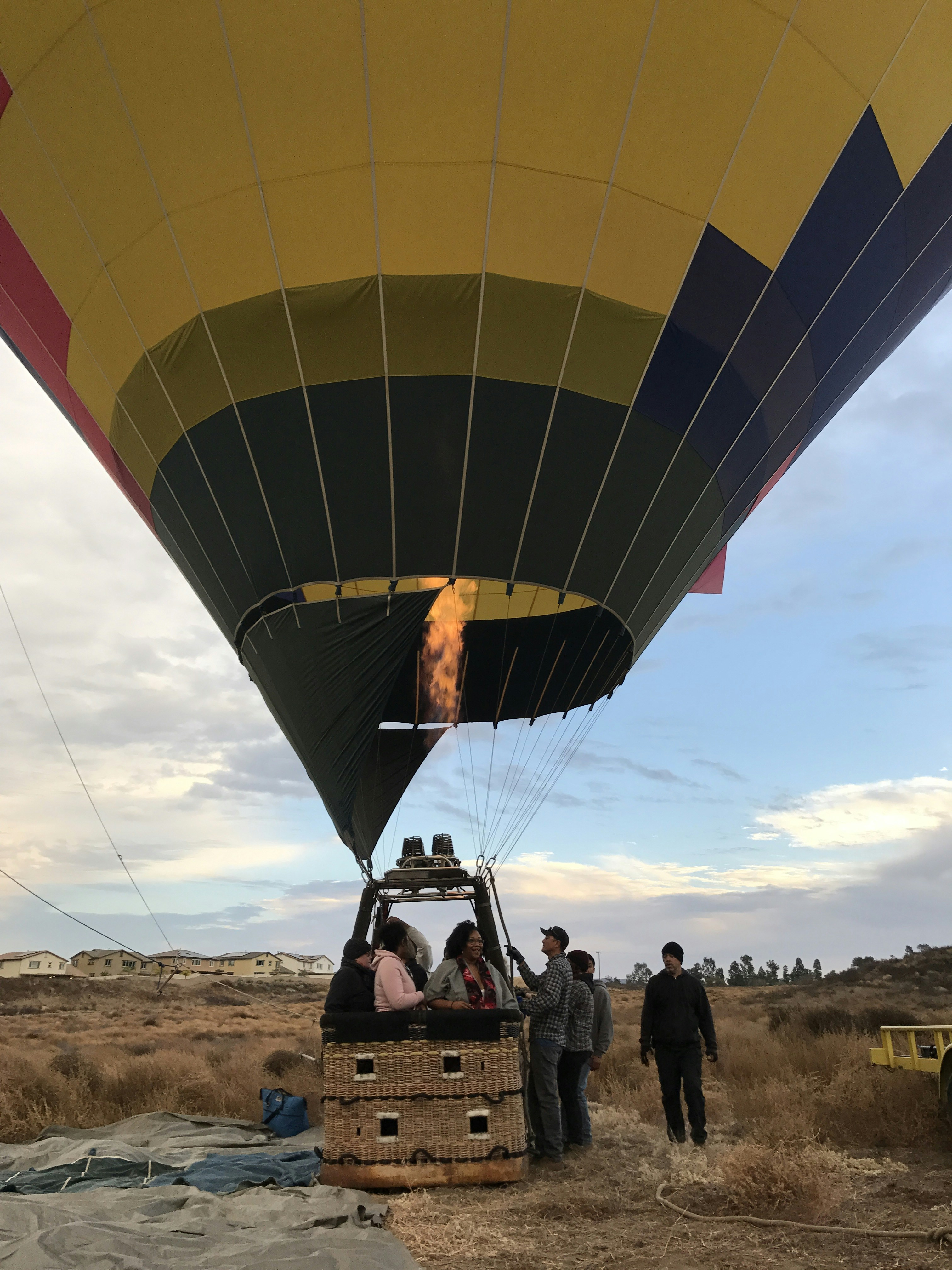 Beneath the Striped Giant: Prep for Lift-Off Under a Flame-lit Balloon
