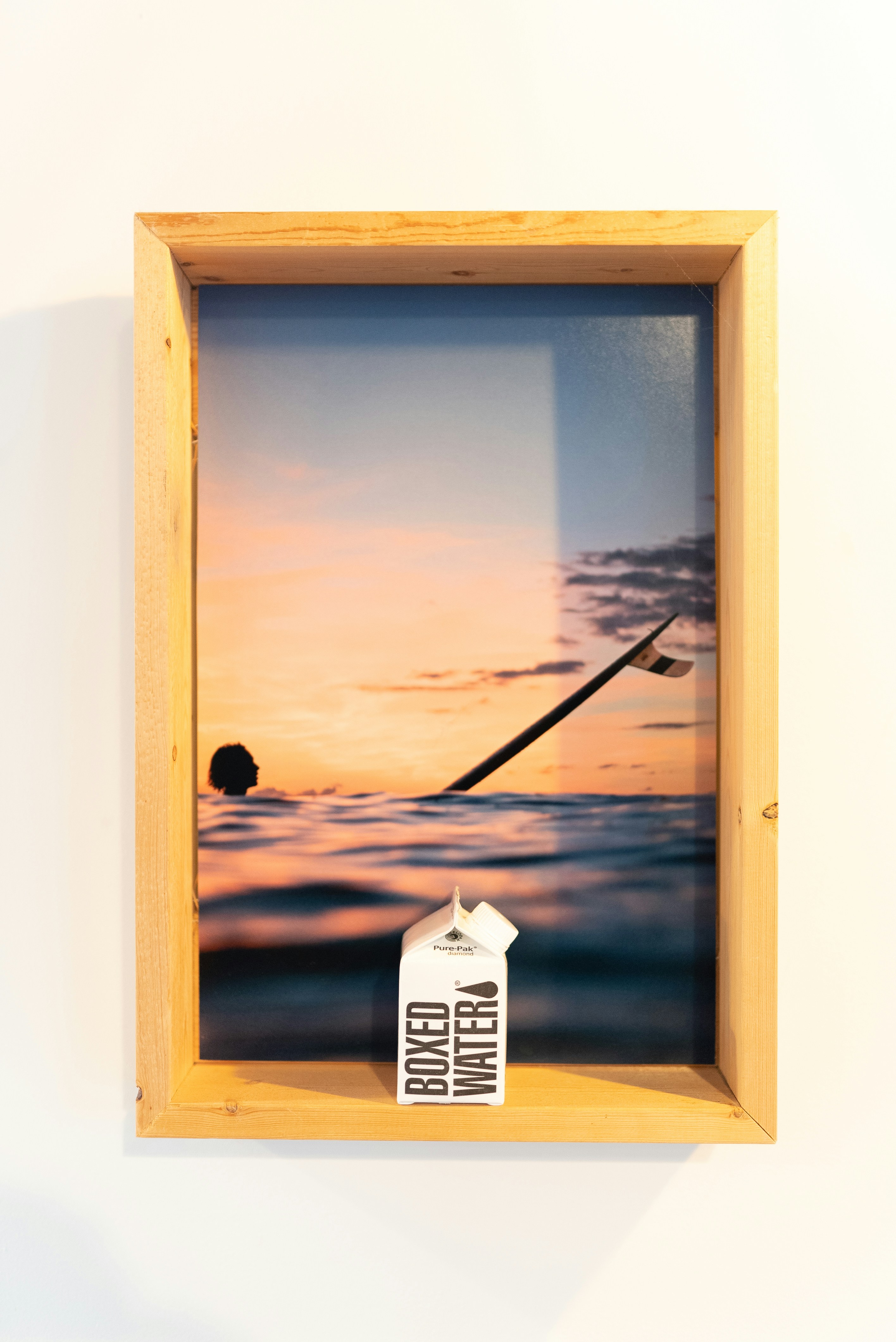Framed Ocean Vista: Sunset, Paddle, and the Boxed Water Tag
