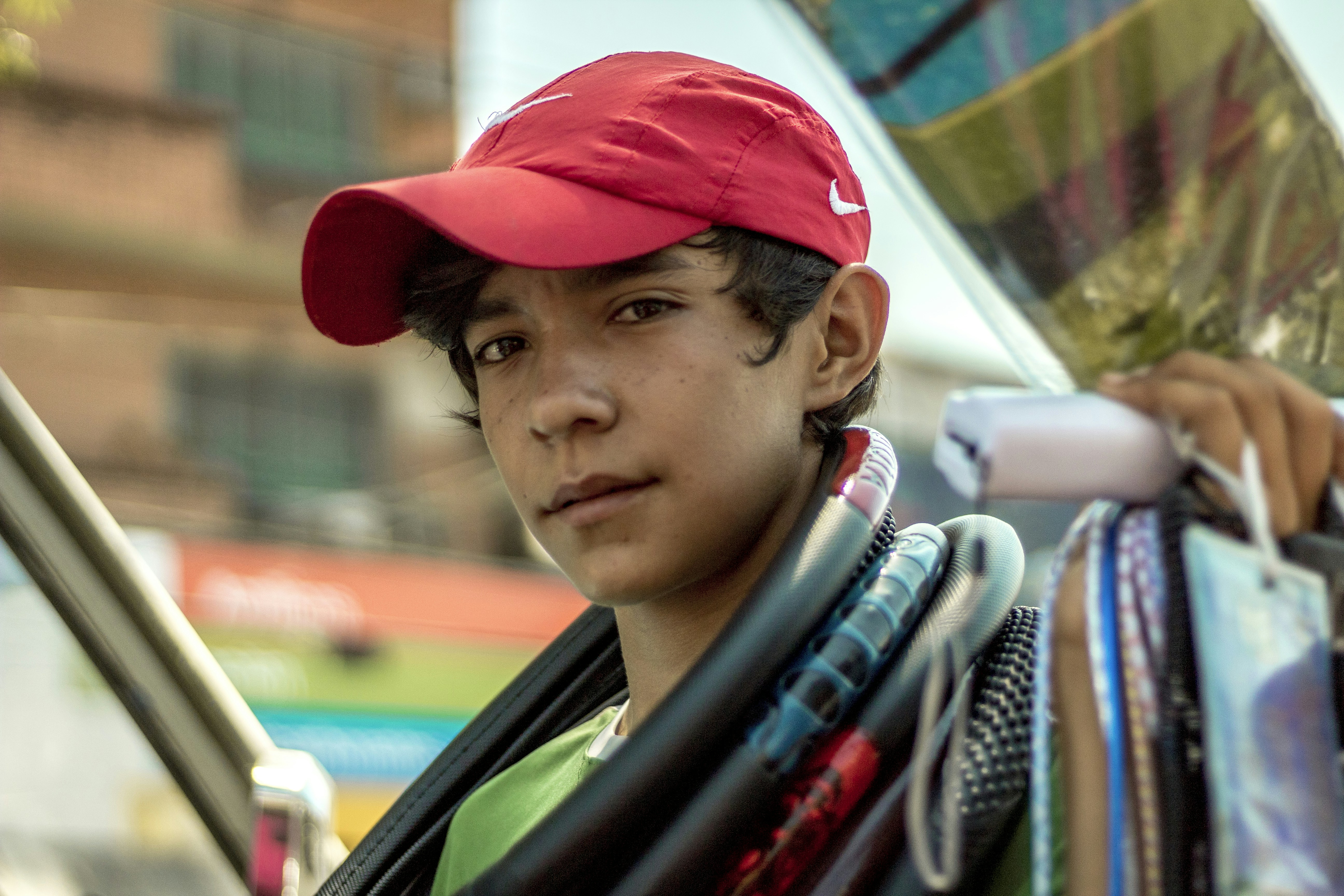 Red Cap, Green Life: A Quiet Gaze Among The Market Hues