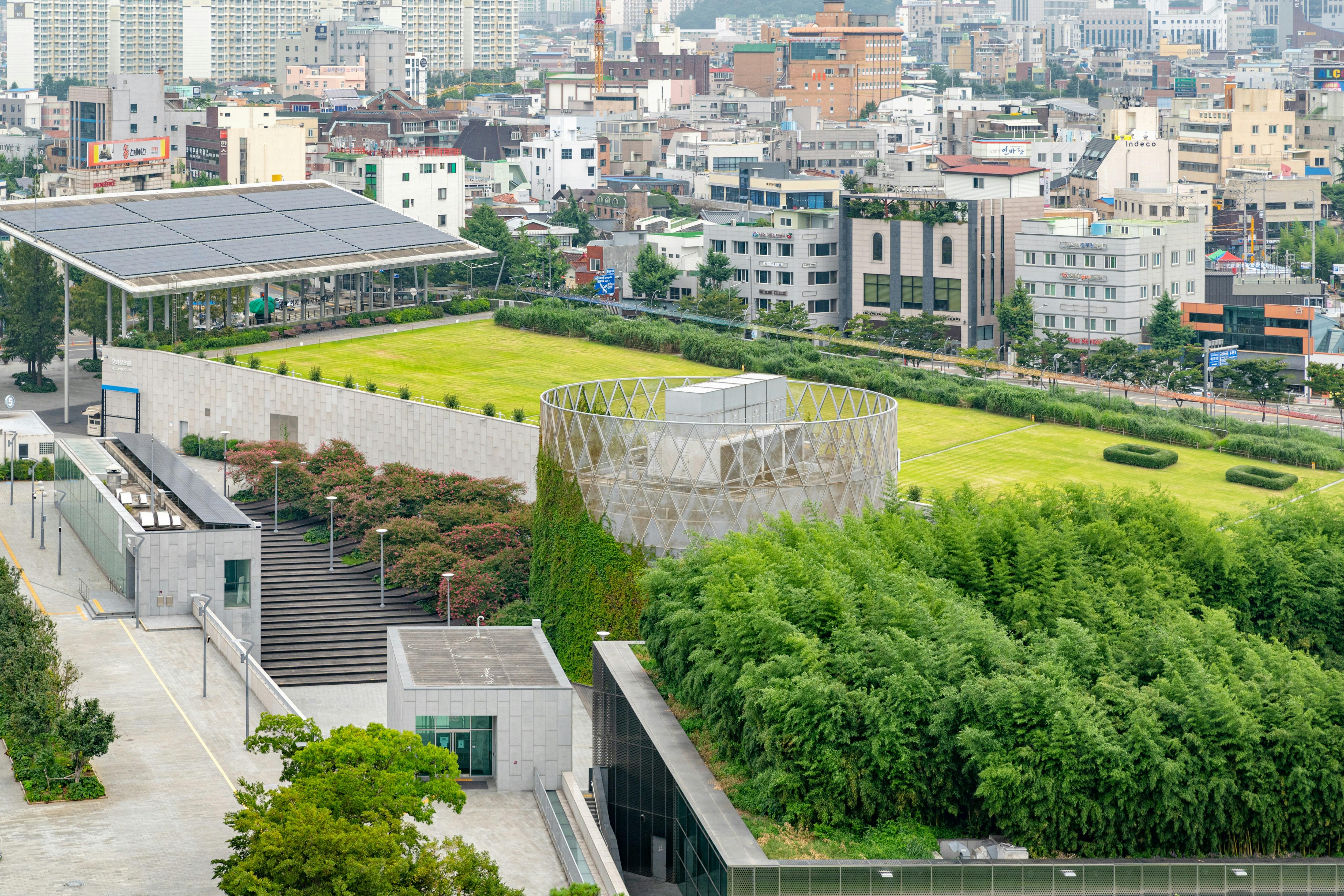 Circular Lattice on a Rooftop Garden Overlooking a Dense Cityscape