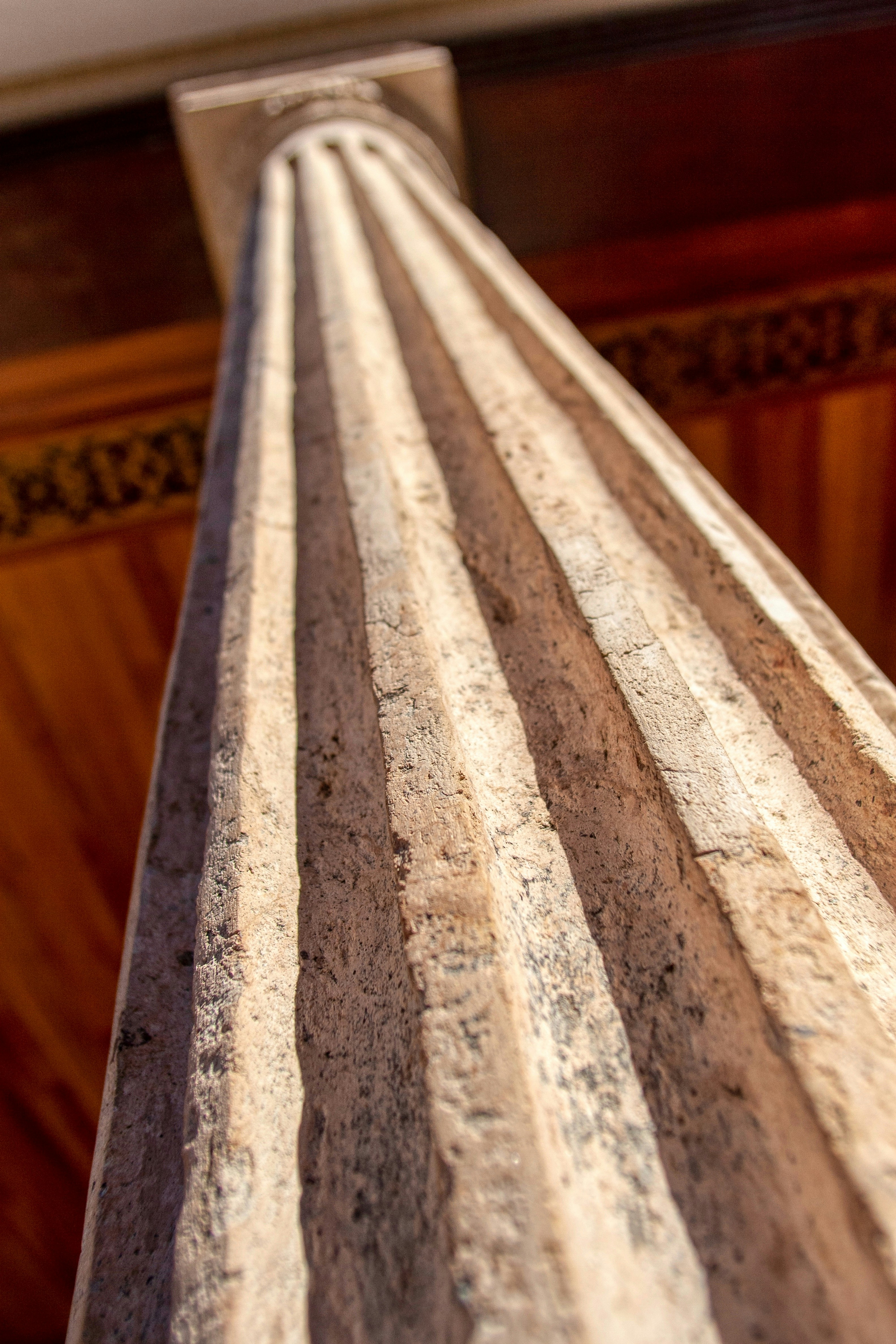 Upward Gaze: A Weathered Fluting Reaches Toward the Ceiling