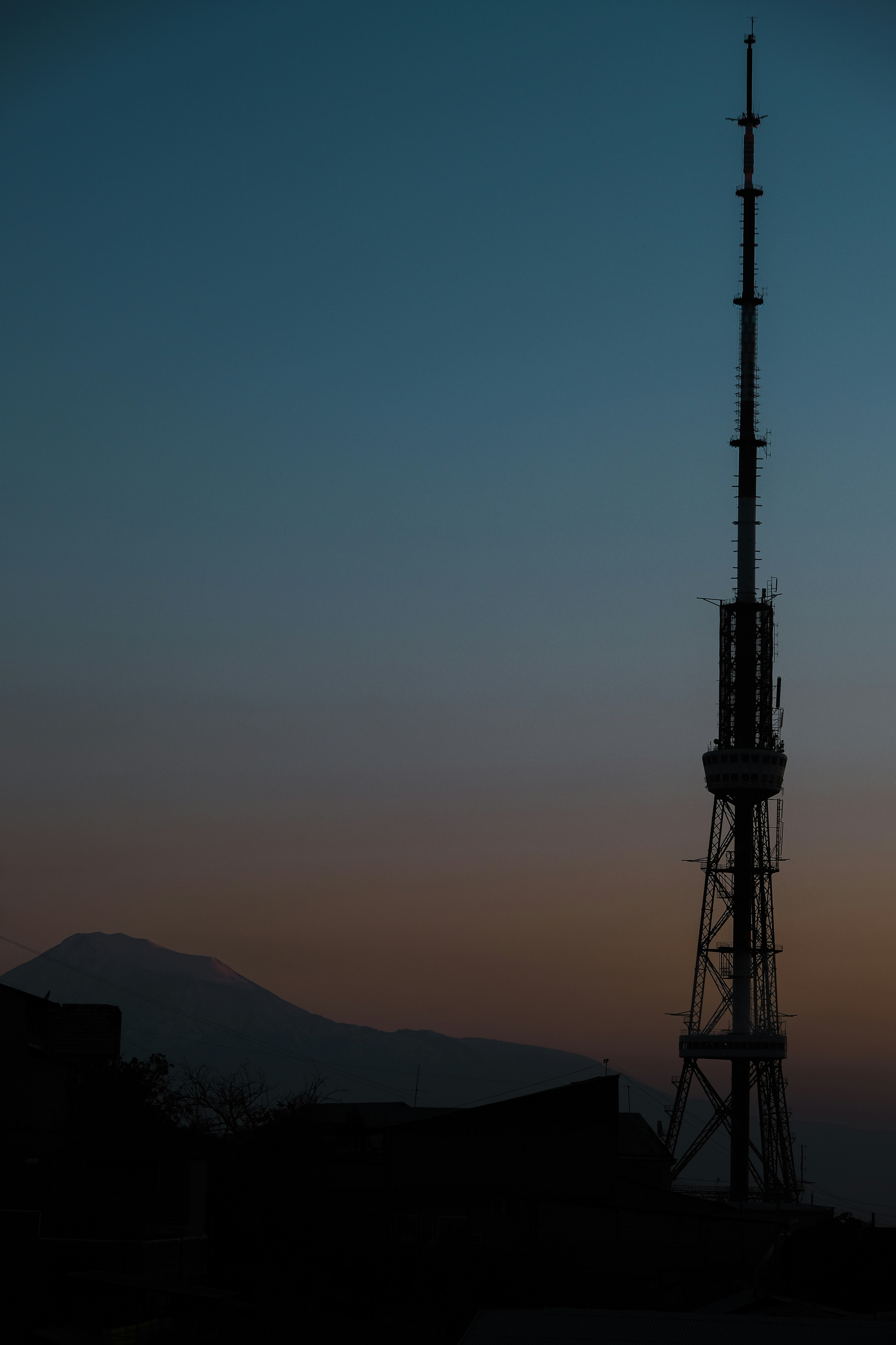 Dusk Spire: The Silent Radio Tower Framing a Mountain Horizon