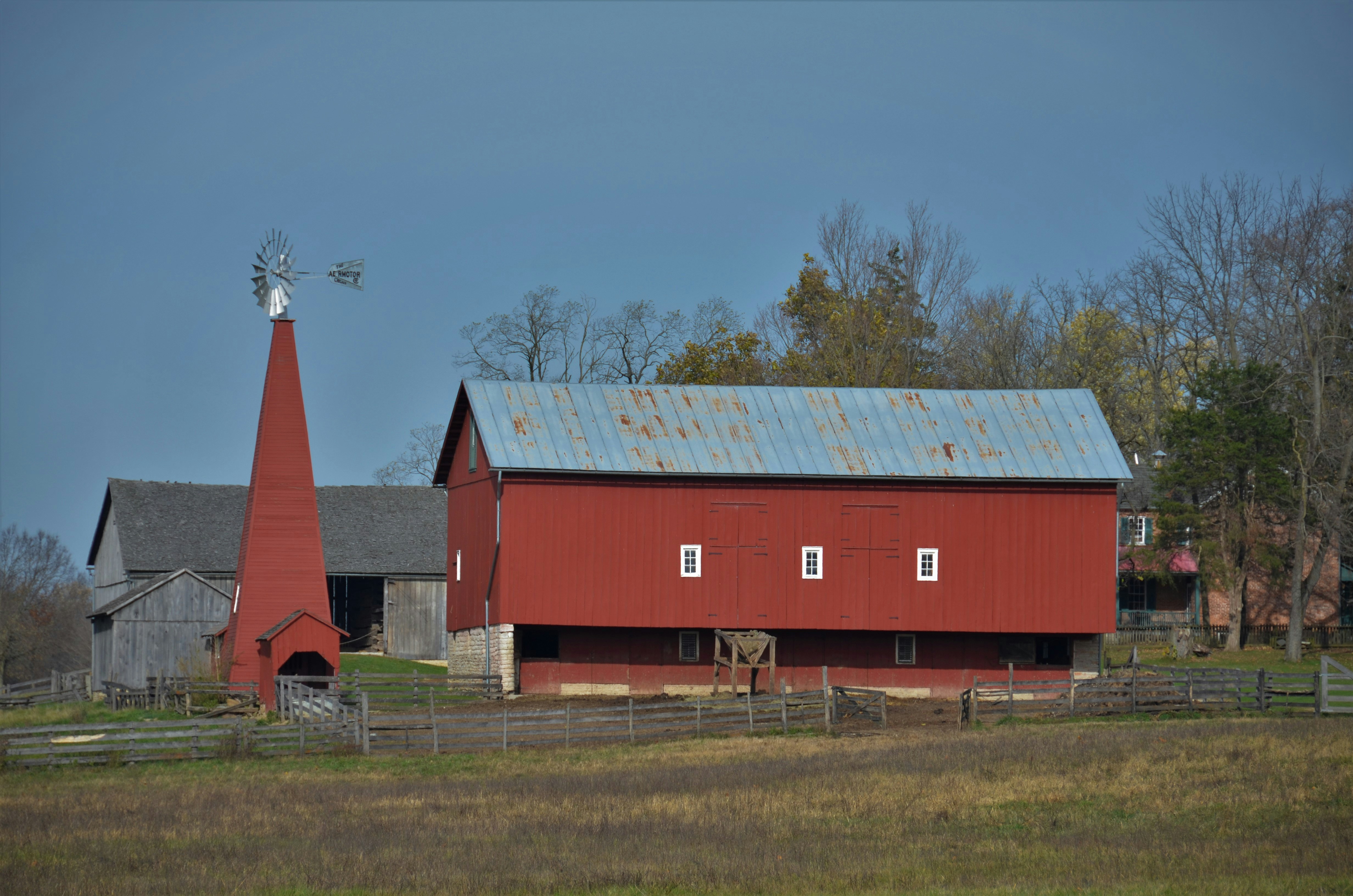 Red barn with tin roof and windmill