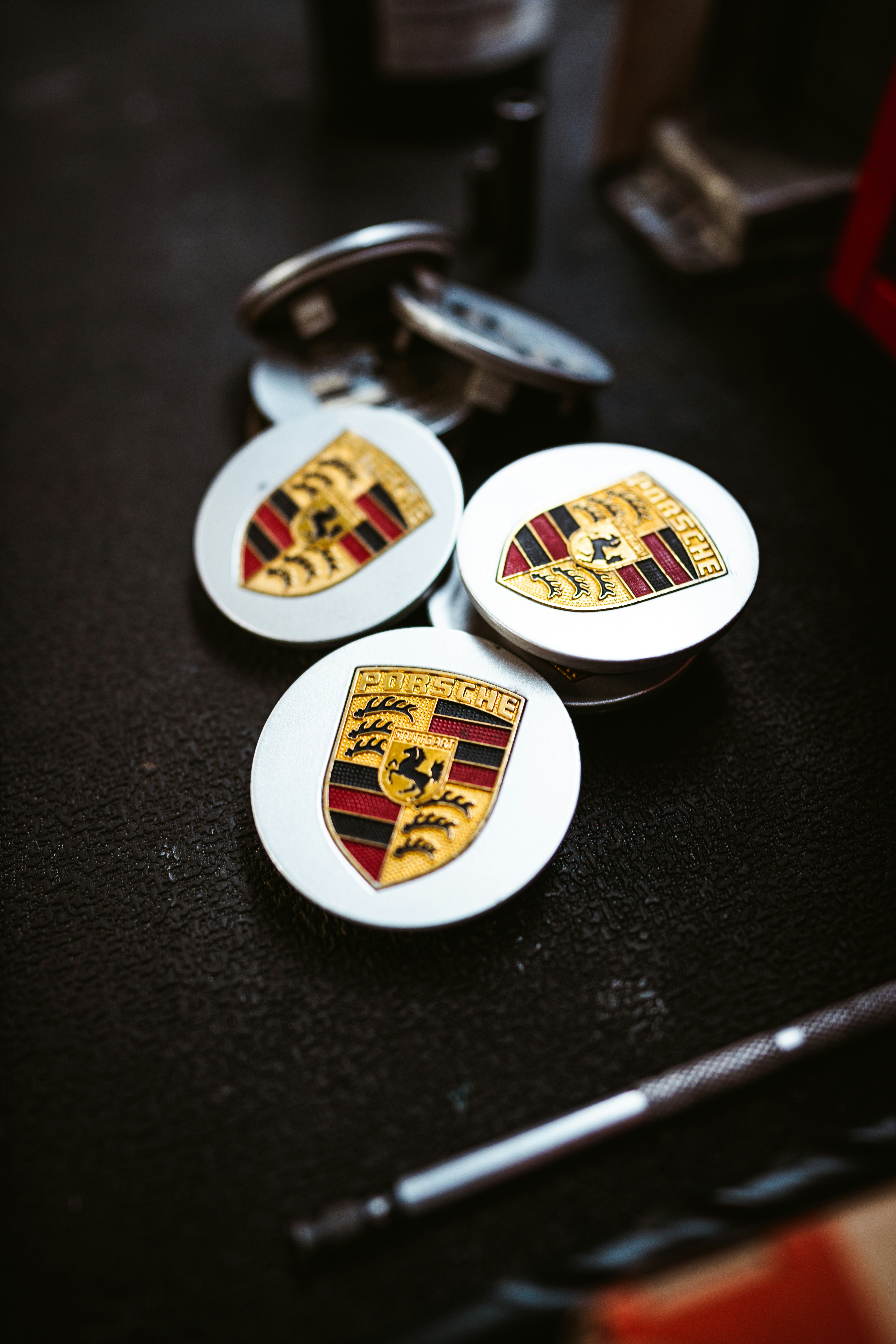 Emblem Workshop: Porsche Crest Caps in Quiet Focus